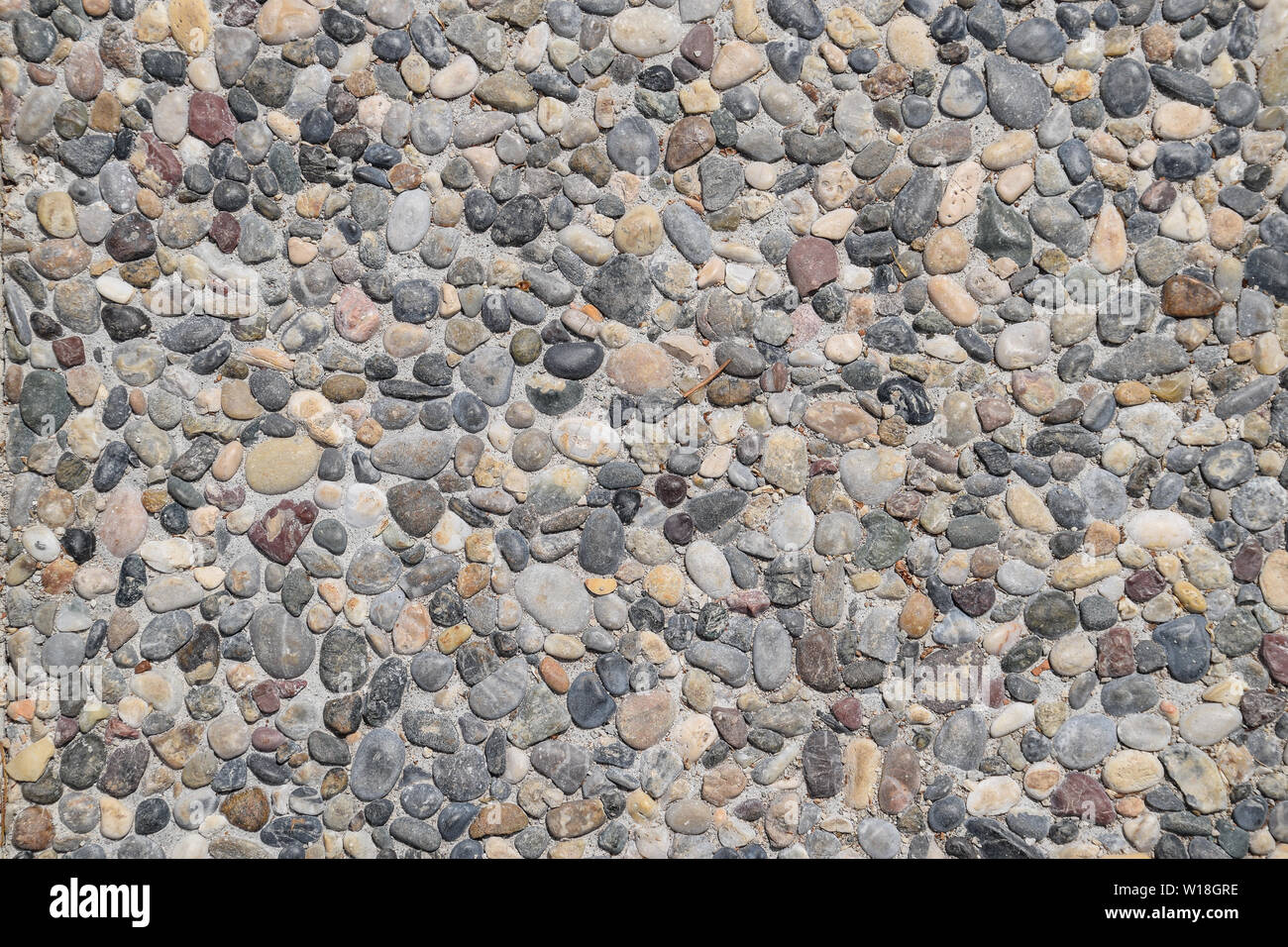 Background texture of the pavement of stone pellets. Pebbles in ...