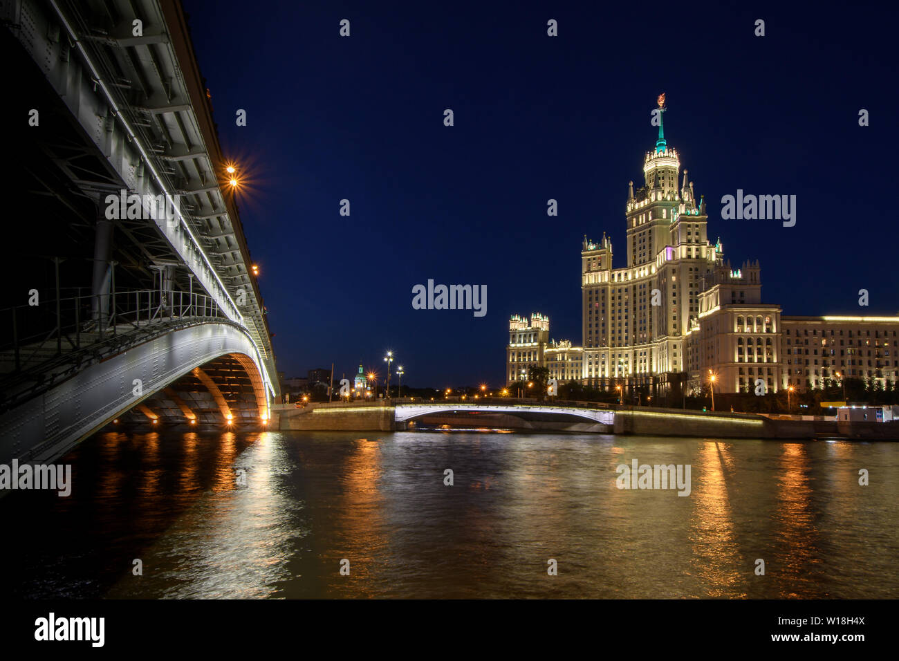View of night Moscow. Stalin-era skyscraper and bridge over the Moscow ...