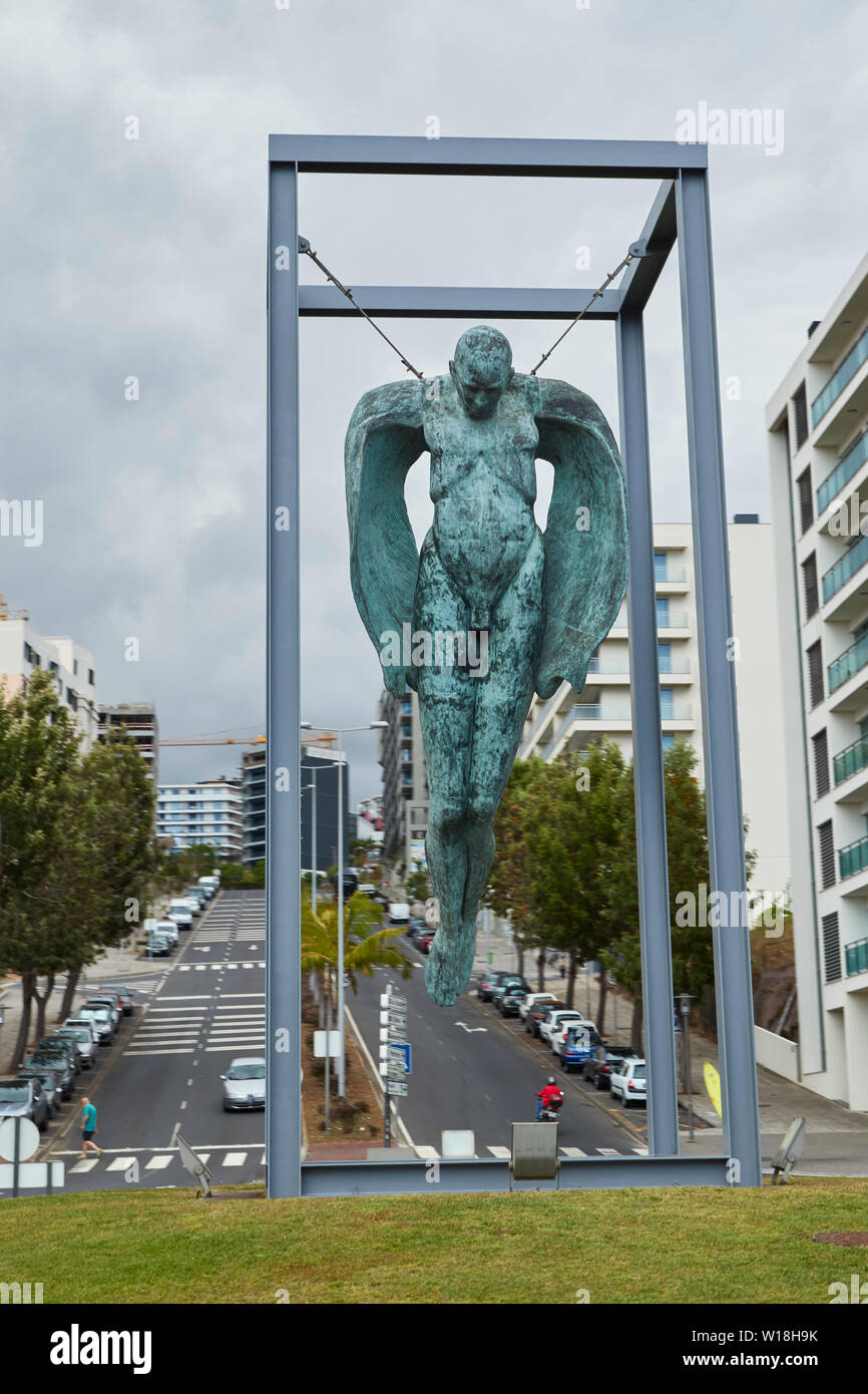 Hanging angel street art memorial to Maderian workers, Funchal, Madeira ...