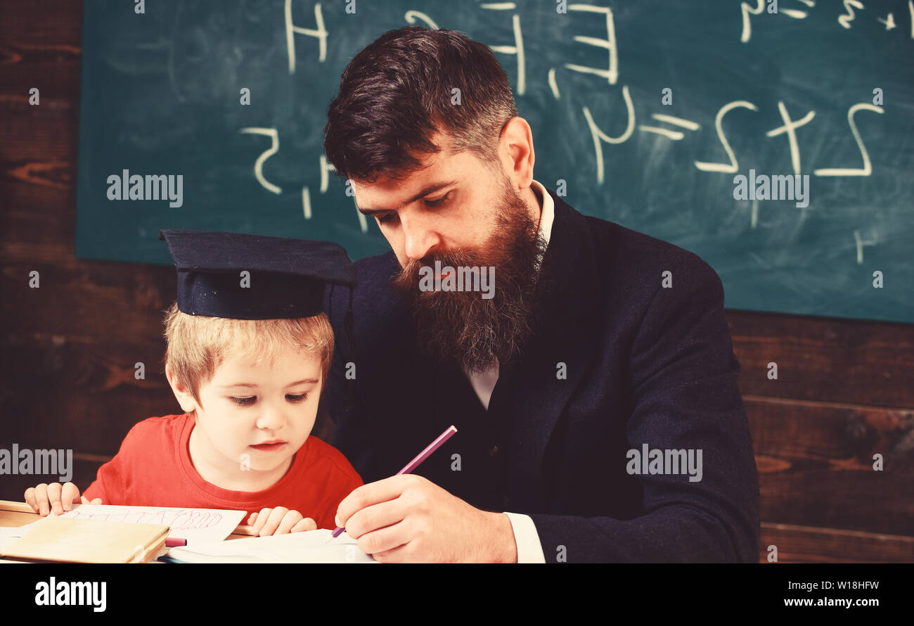 Homeschooling concept. Teacher in formal wear and pupil in mortarboard ...