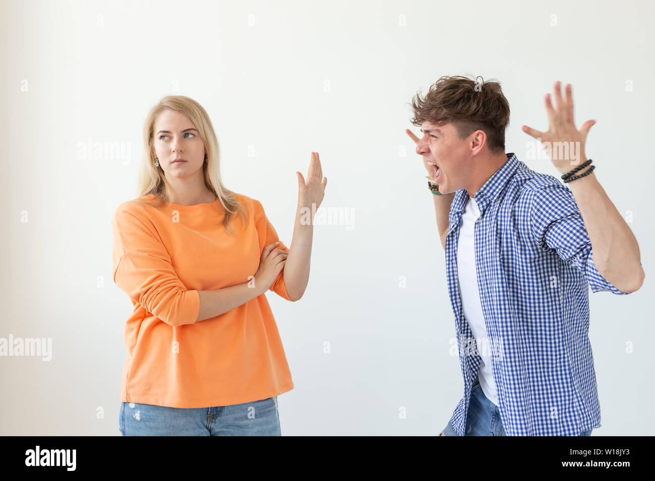 Young hipster guy shouts raising his hands up to his beloved girl ...