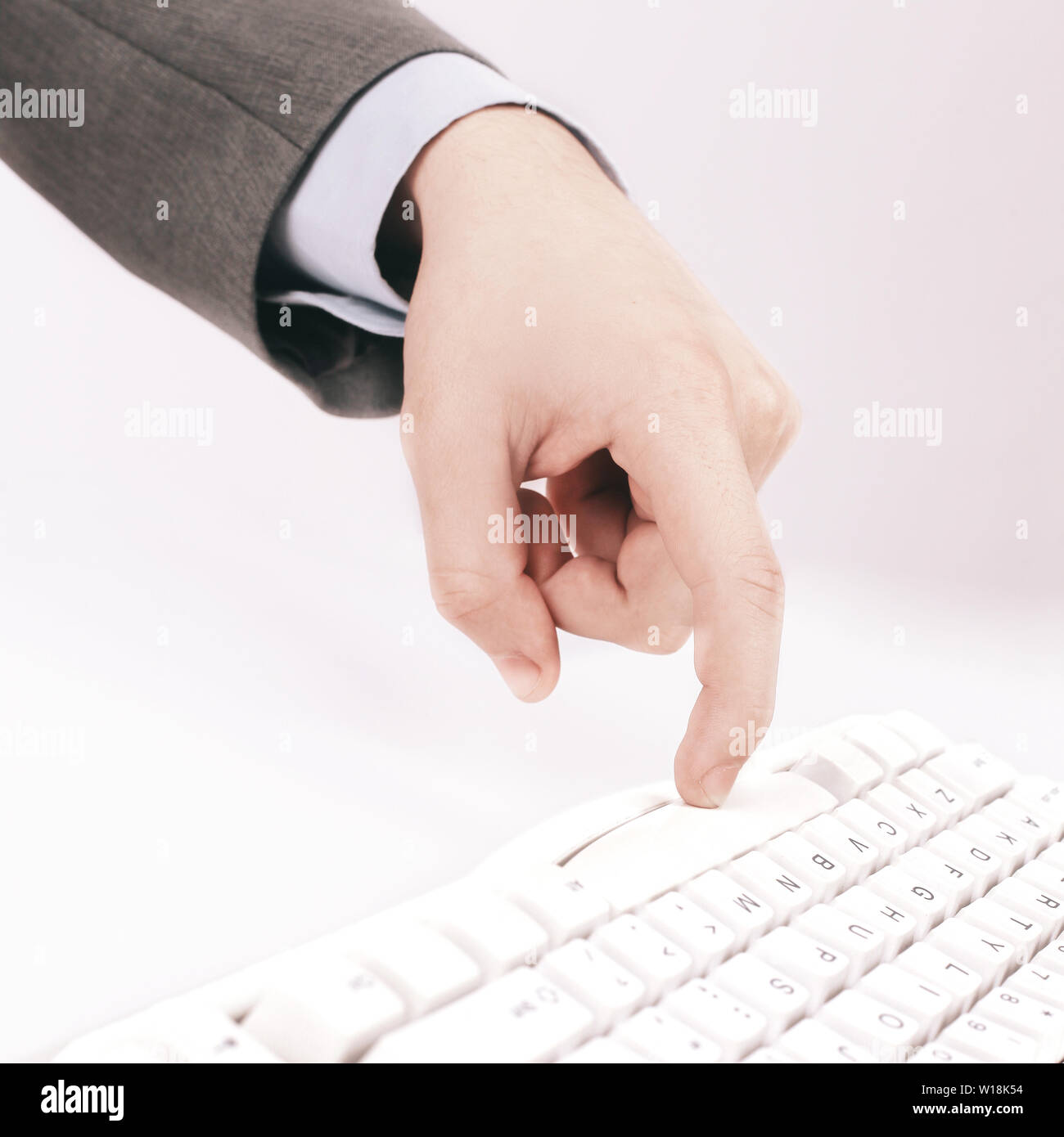 closeup. businessman press a key on the computer keyboard.isolated on ...
