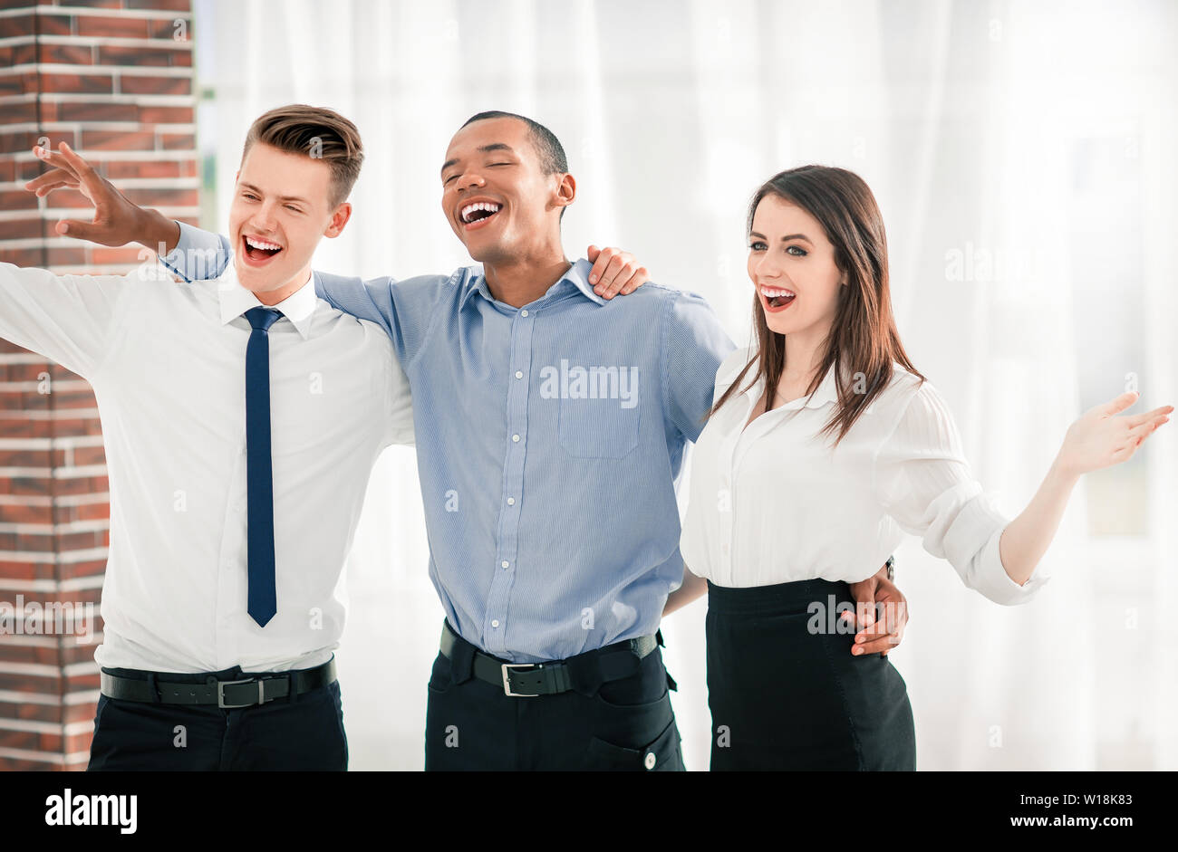very happy business team in the background of the office.the concept of ...