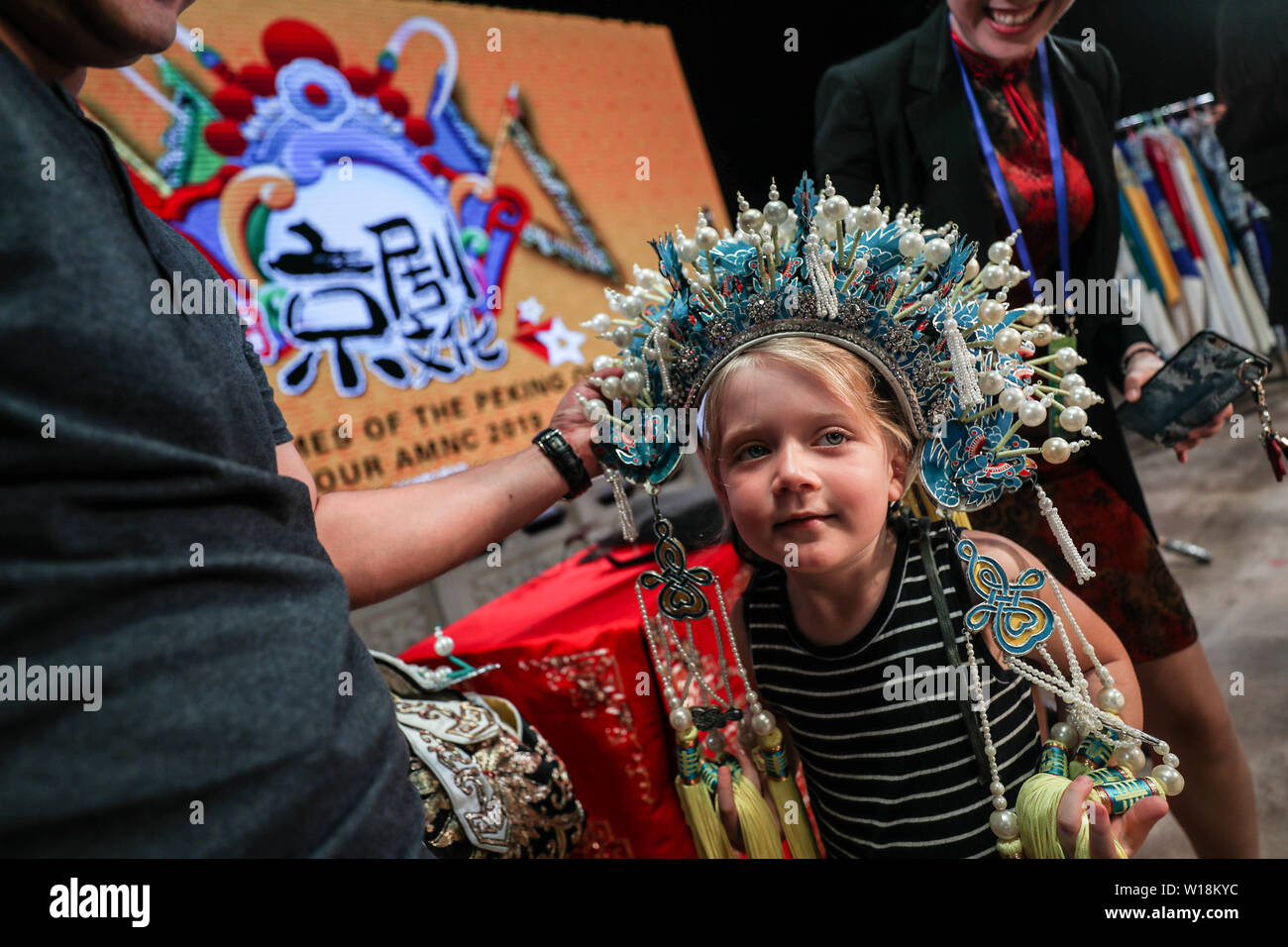 Dalian, China's Liaoning Province. 1st July, 2019. A child tries the ...