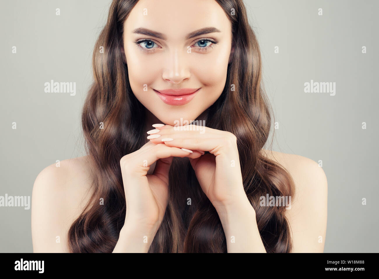 Beautiful woman with long healthy shiny curly hair portrait Stock Photo ...