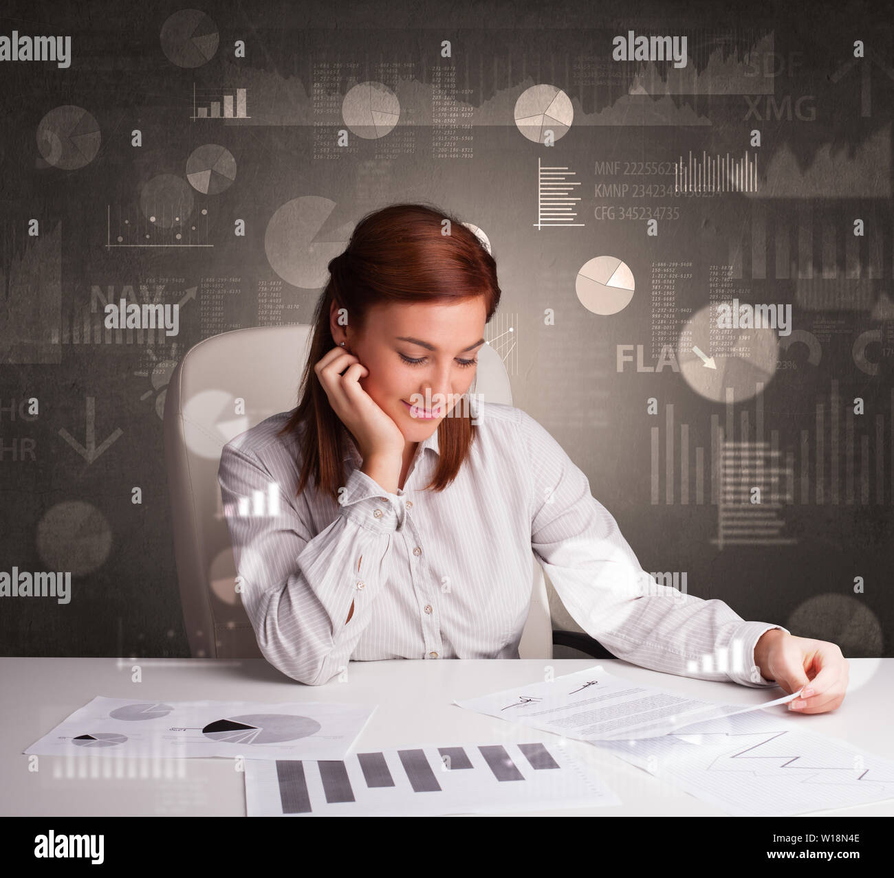 Young manager at the office making report and statistics with ...