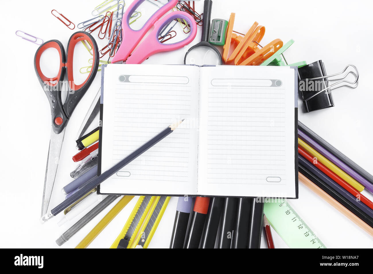 opened Notepad on office supplies on white background Stock Photo - Alamy