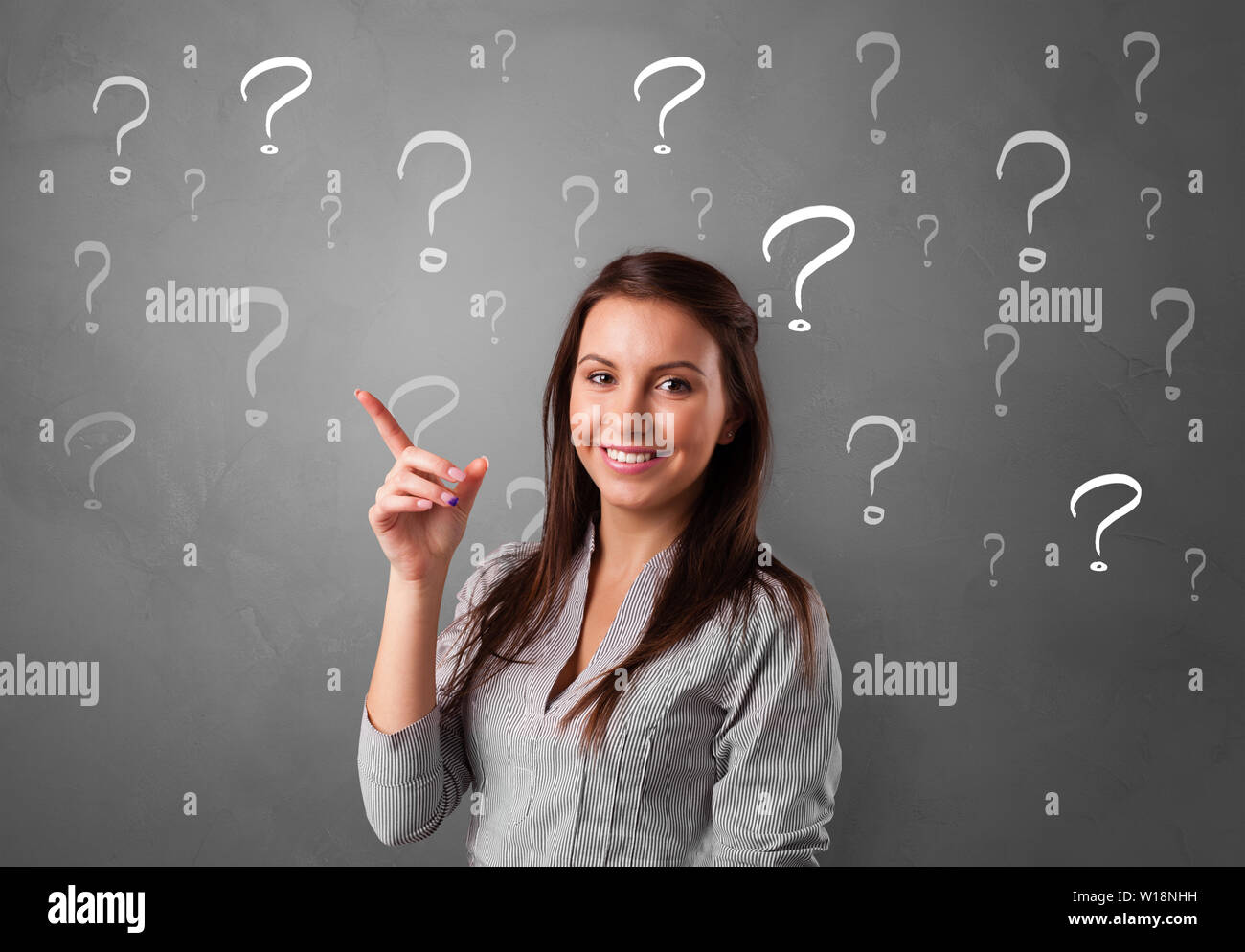 Person with question marks around face Stock Photo - Alamy