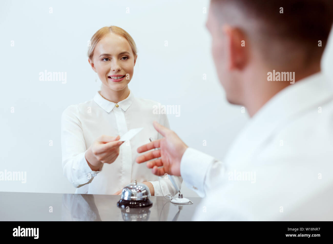 man at hotel reception Stock Photo - Alamy