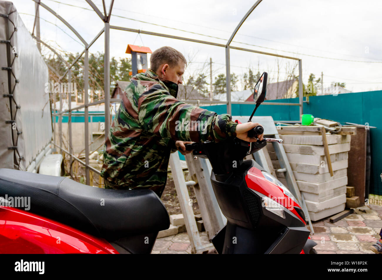 pictured in the photo young man on a red motorcycle outdoor Stock Photo ...