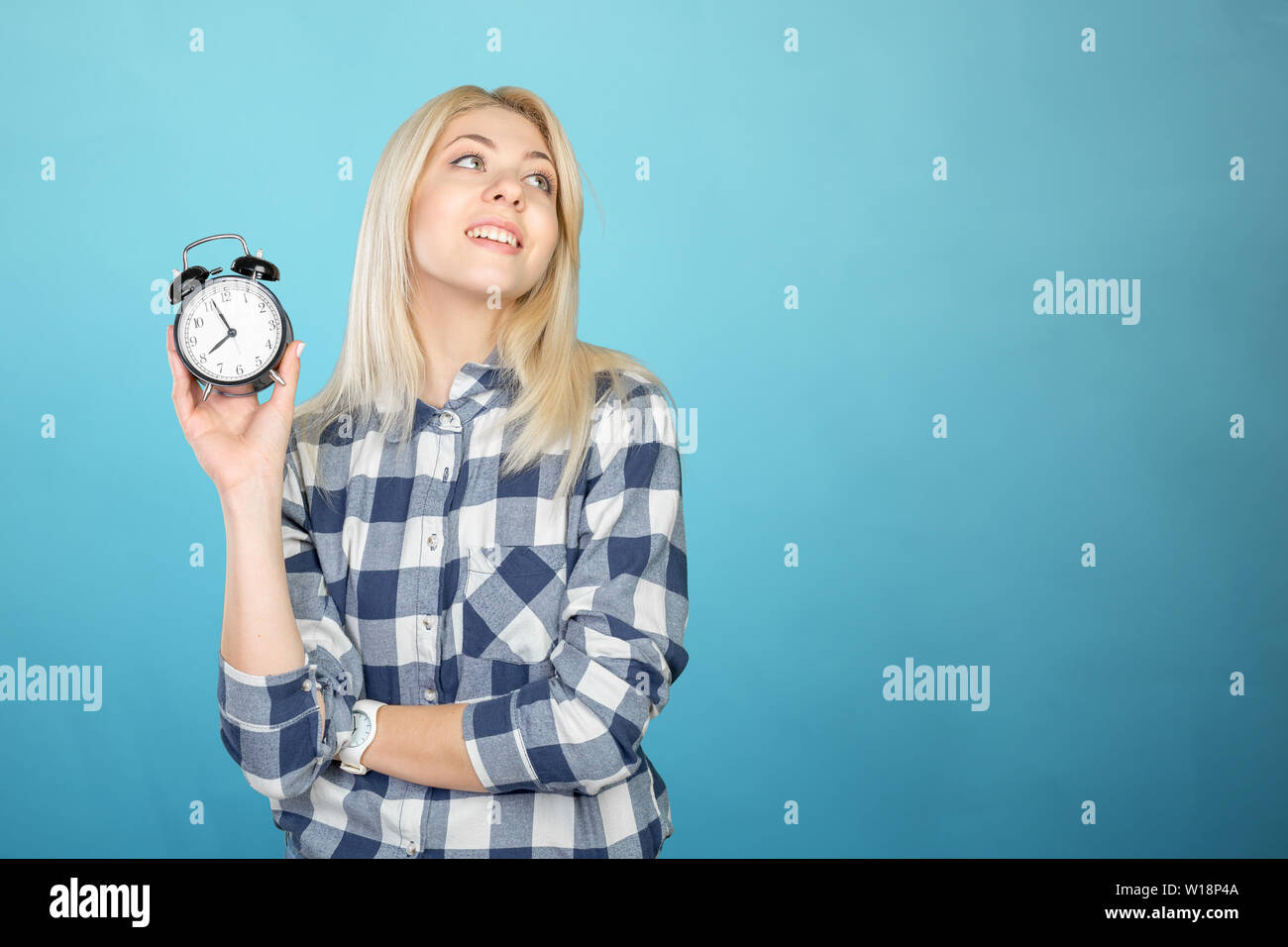 young woman pointing on clock Stock Photo - Alamy