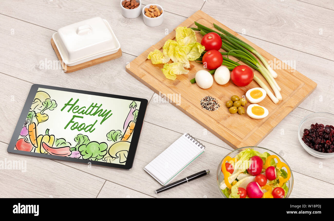 Healthy food composition with tablet Stock Photo - Alamy