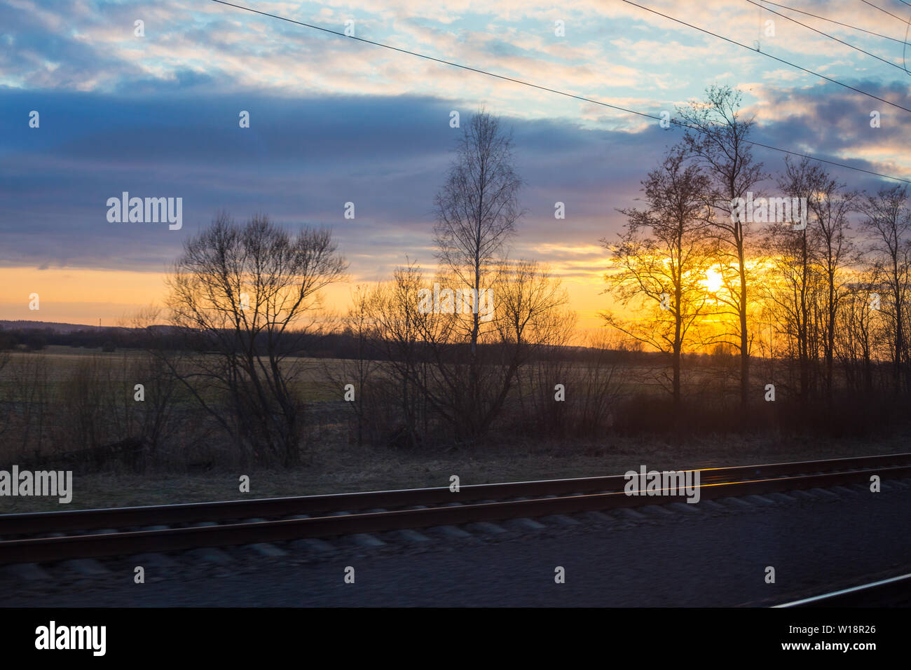 Train window view with dramatic sunset light Stock Photo - Alamy