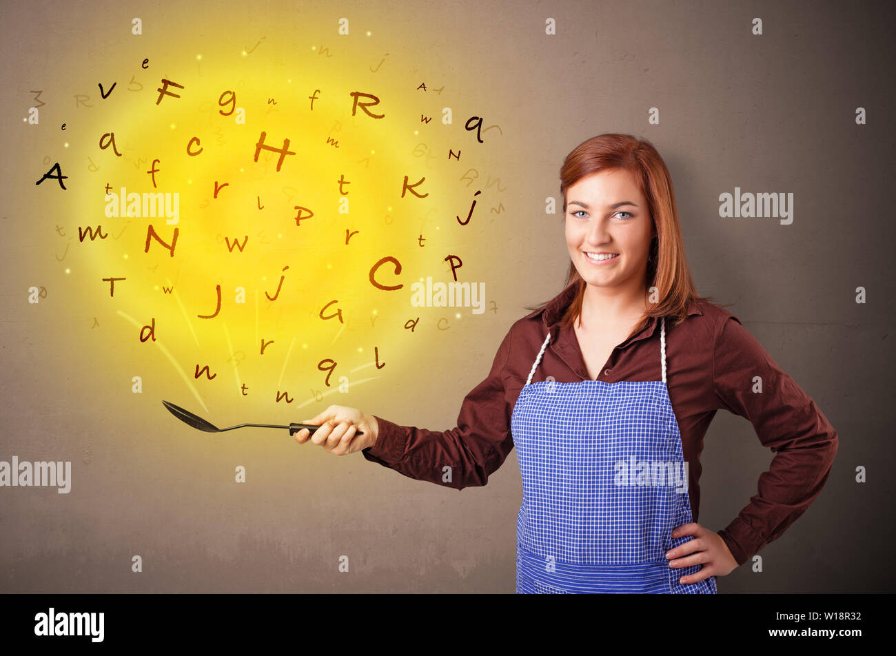 Young person cooking letters in wok Stock Photo - Alamy