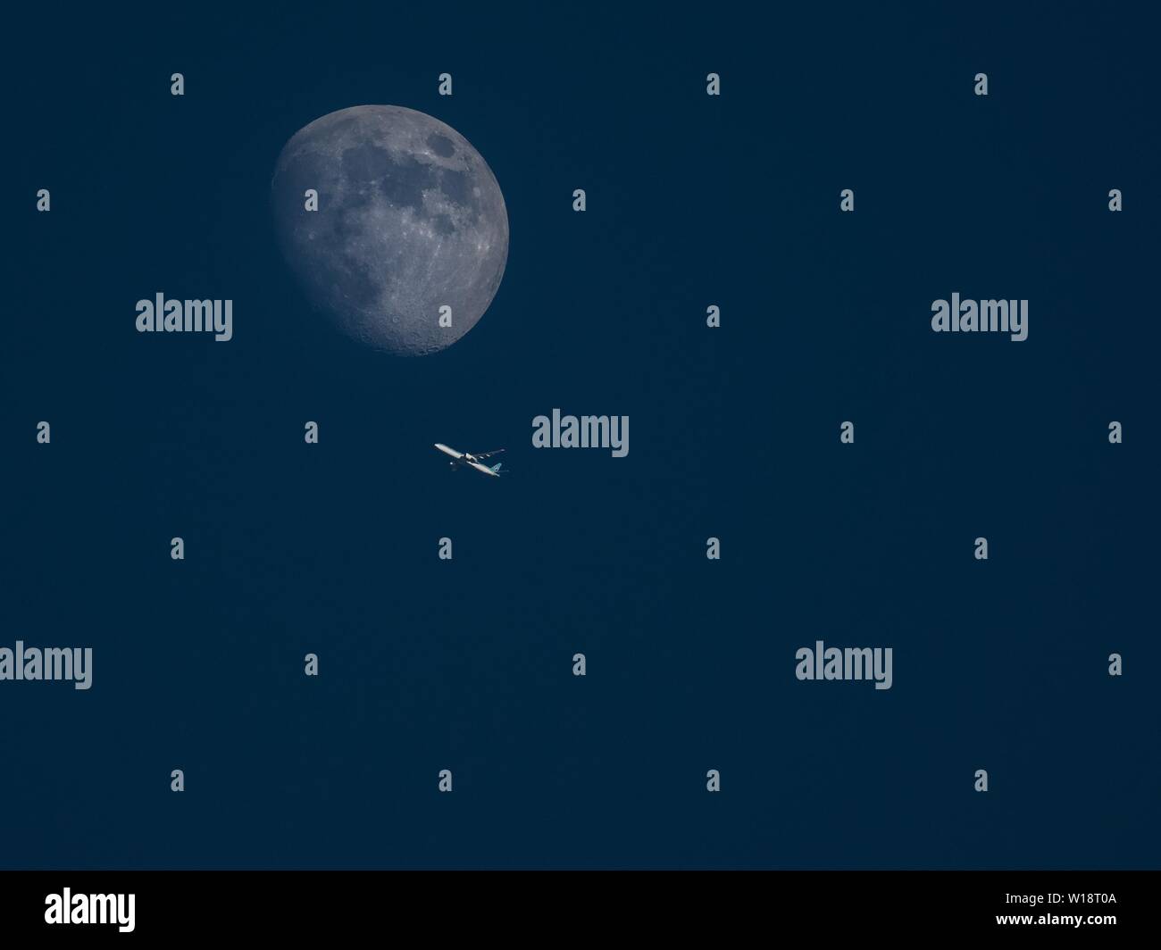 Airliner flying under moon hi-res stock photography and images - Alamy