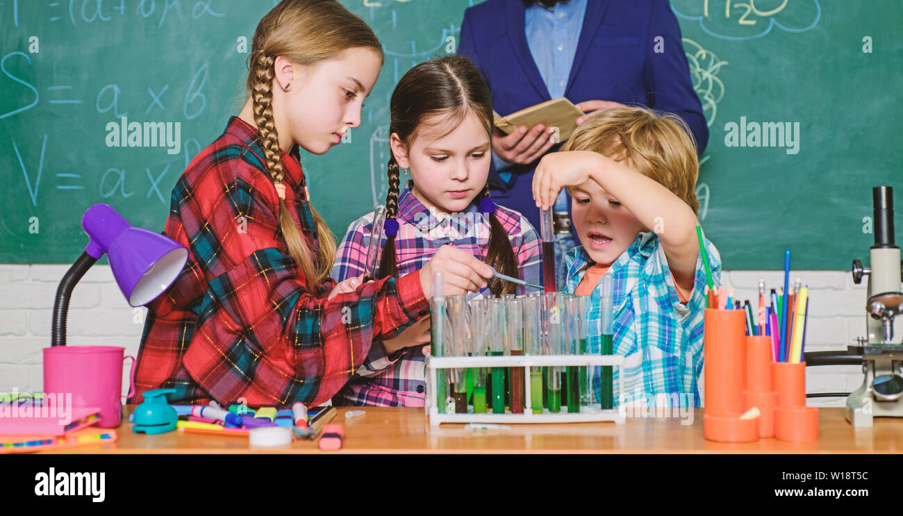 back to school. kids in lab coat learning chemistry in school ...