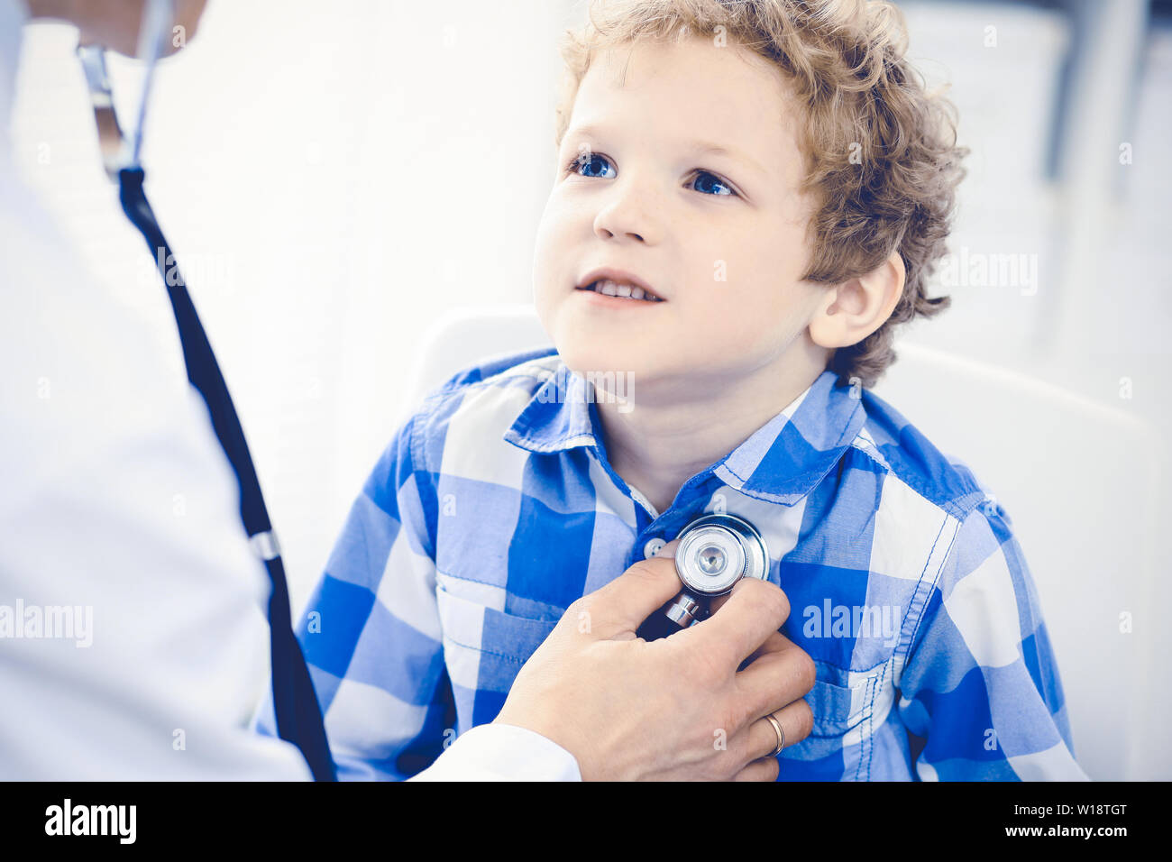 Doctor and patient child. Physician examining little boy. Regular ...