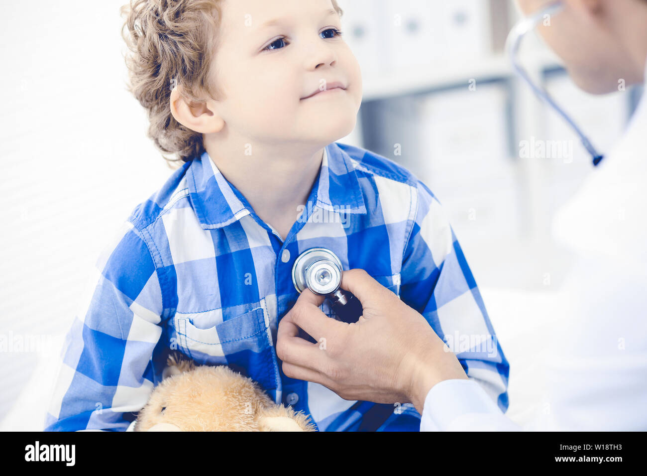 Doctor and patient child. Physician examining little boy. Regular ...