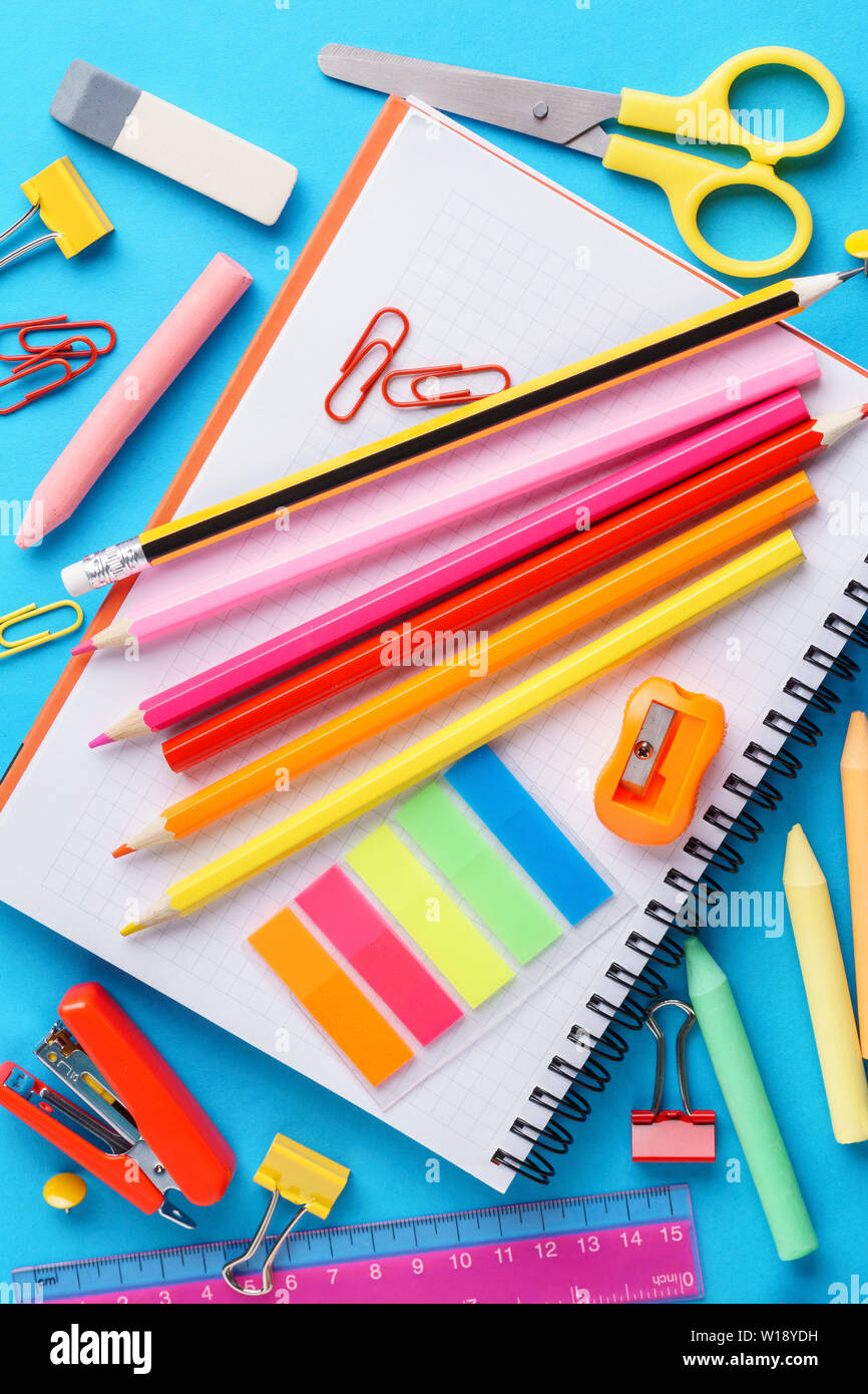 Set of various colorful school stationery and supplies on blue ...