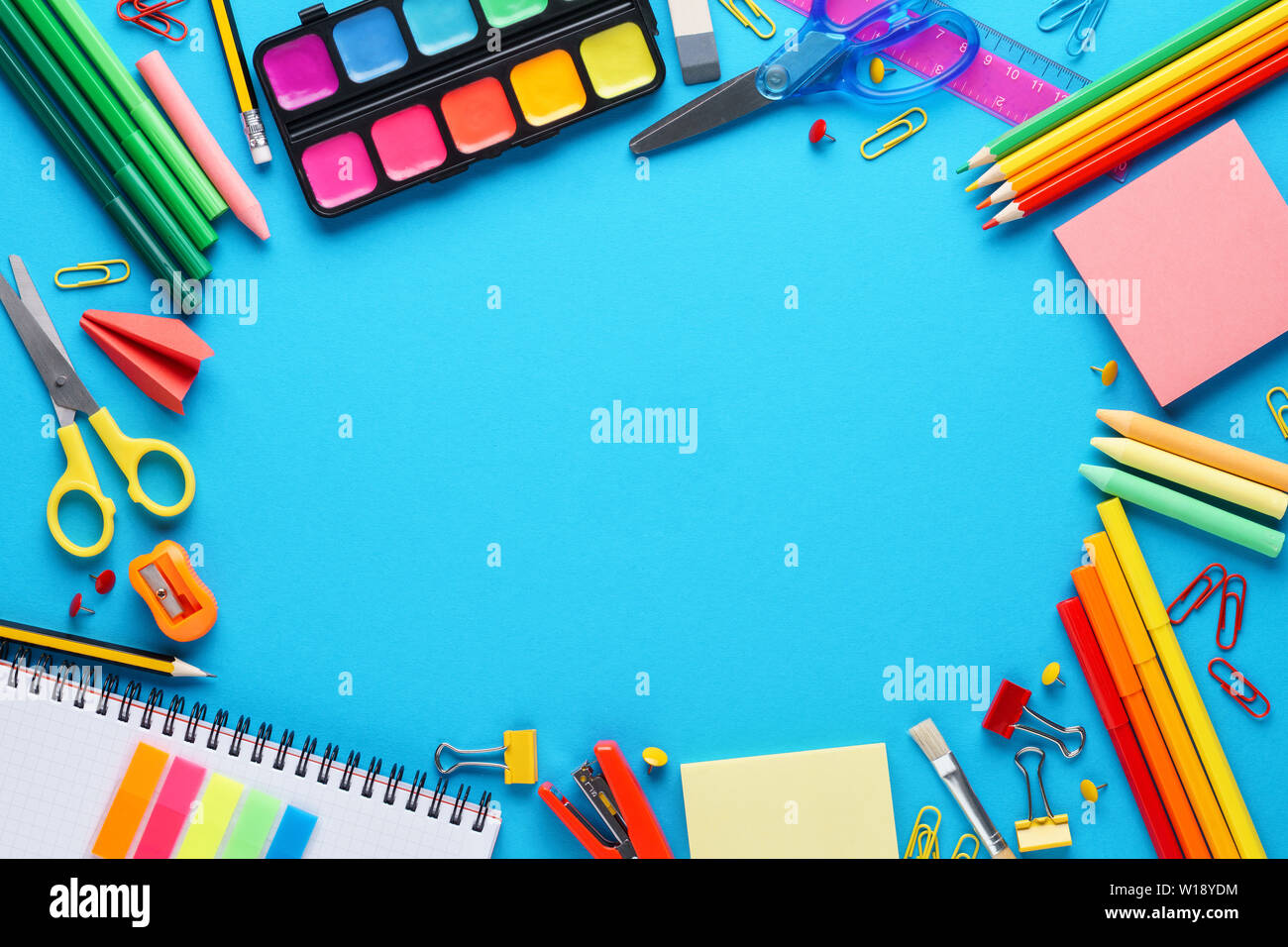 Various colorful stationery on blue background. Back to school frame ...