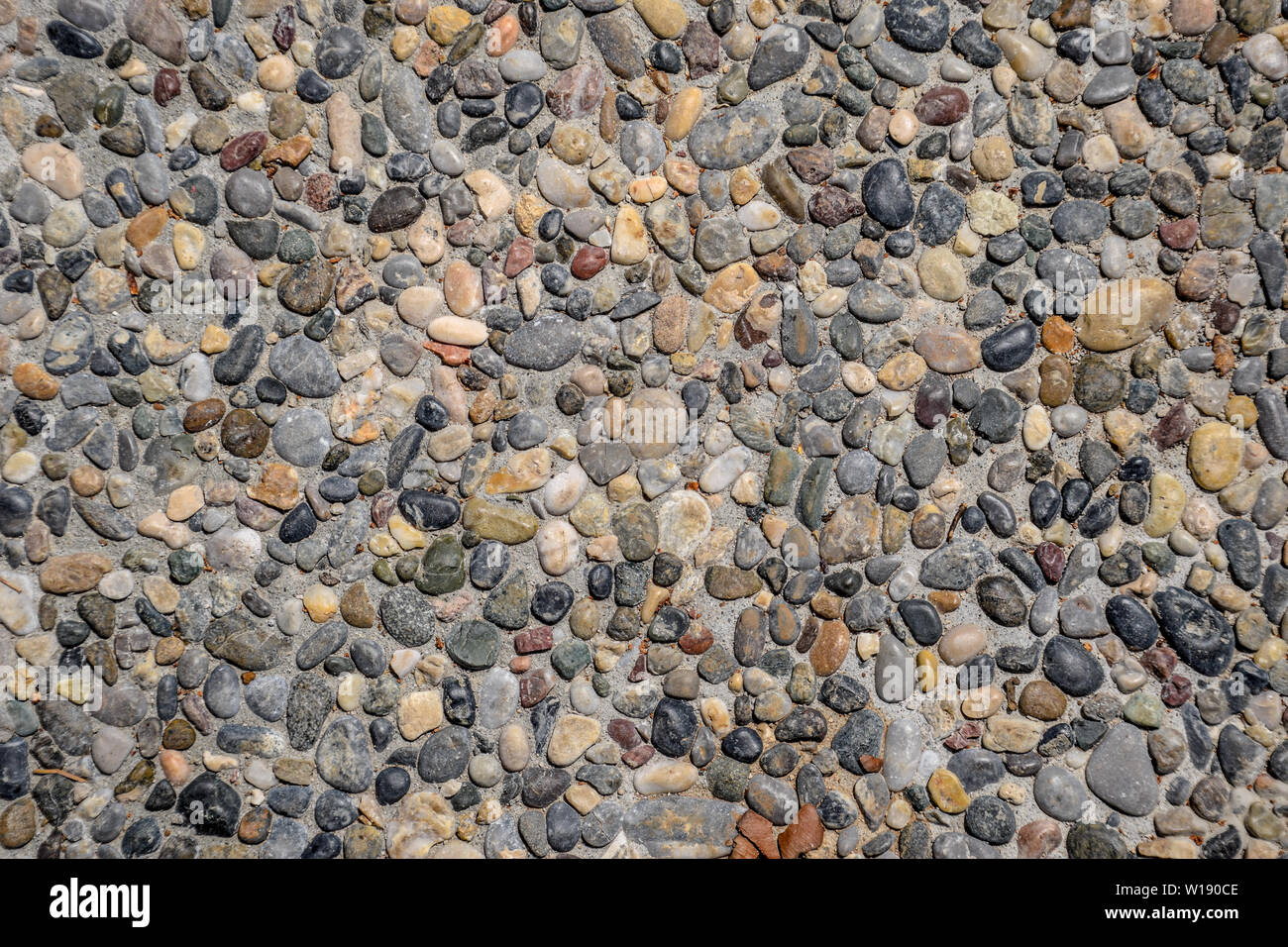 Background texture of the pavement of stone pellets. Pebbles in ...