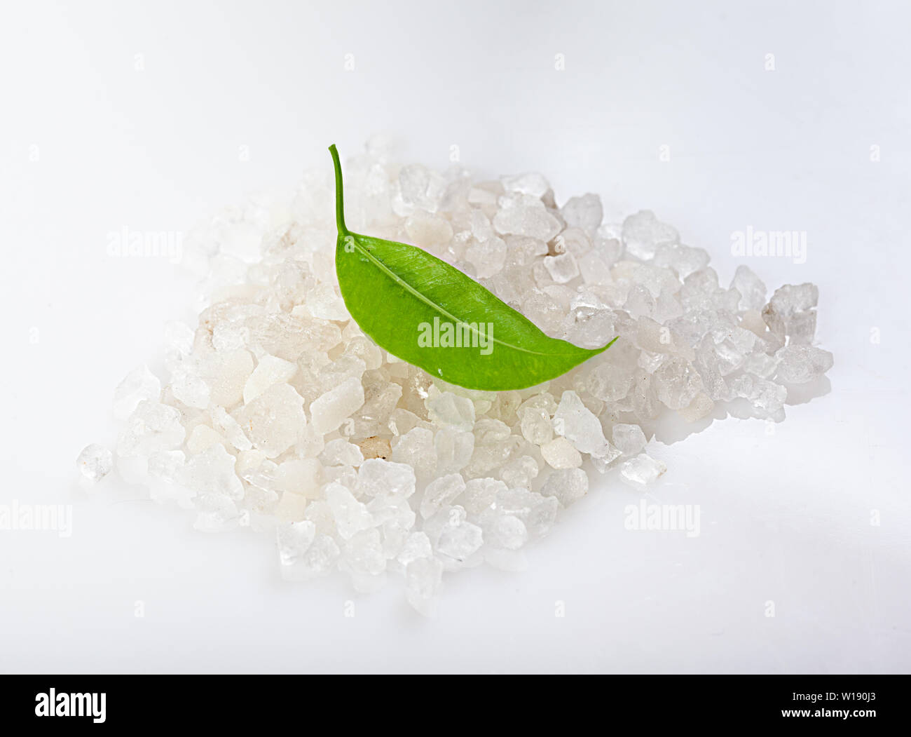 Salt or sea salt with green leaf Stock Photo - Alamy