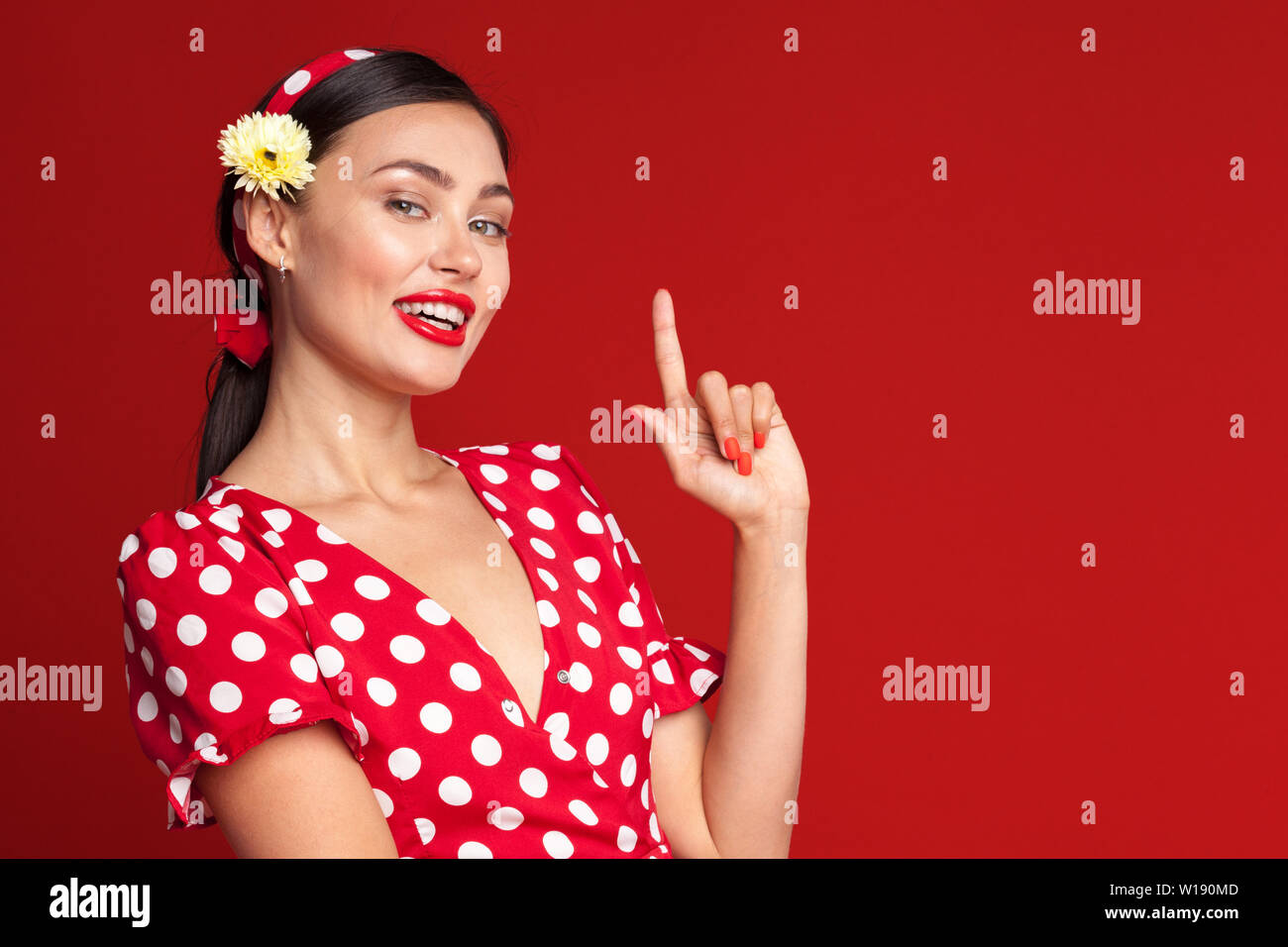 portrait of a beautiful woman pinup retro style pointing Stock Photo ...