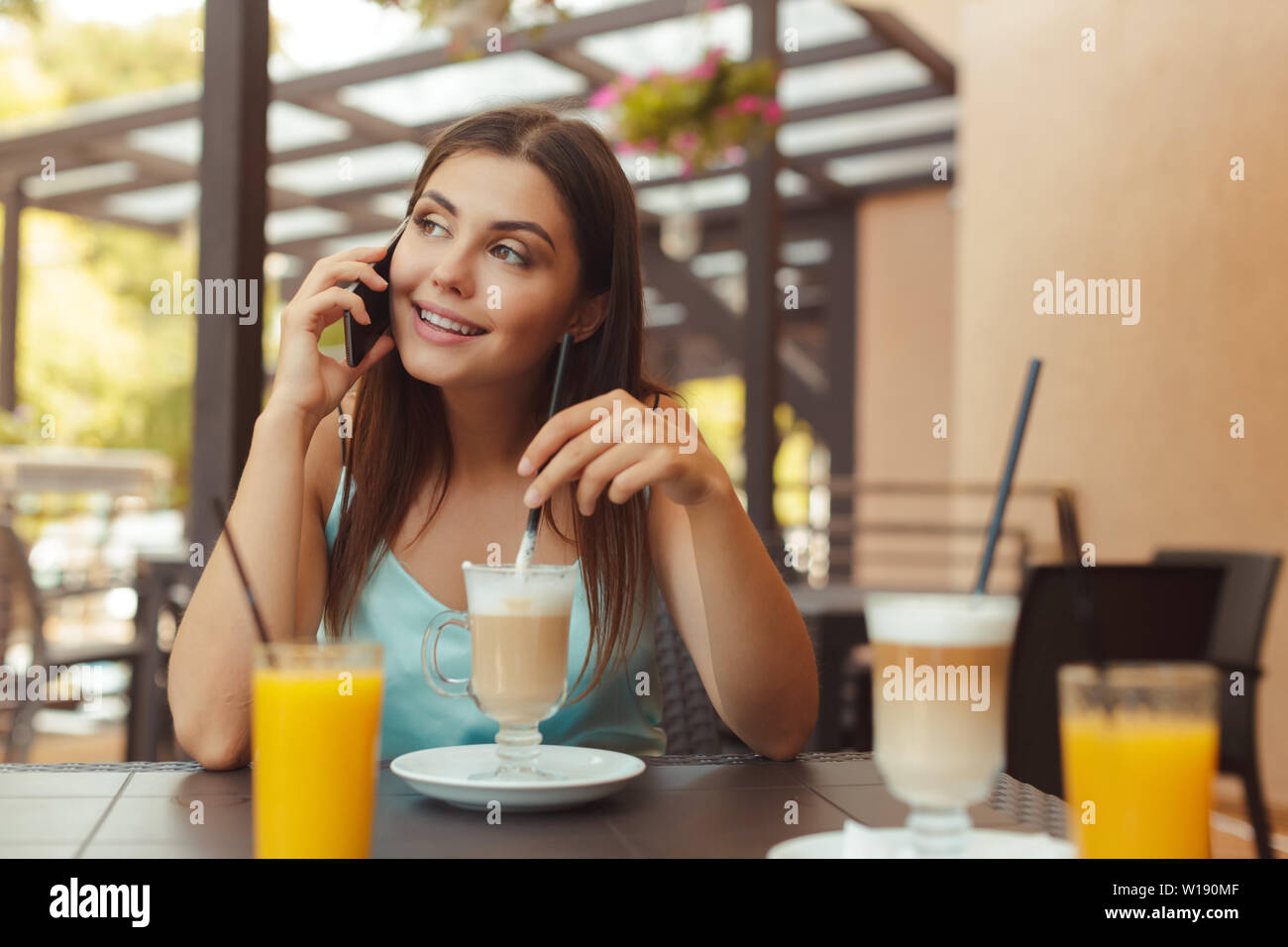 Portrait of beautiful girl using her mobile phone in cafe Stock Photo ...