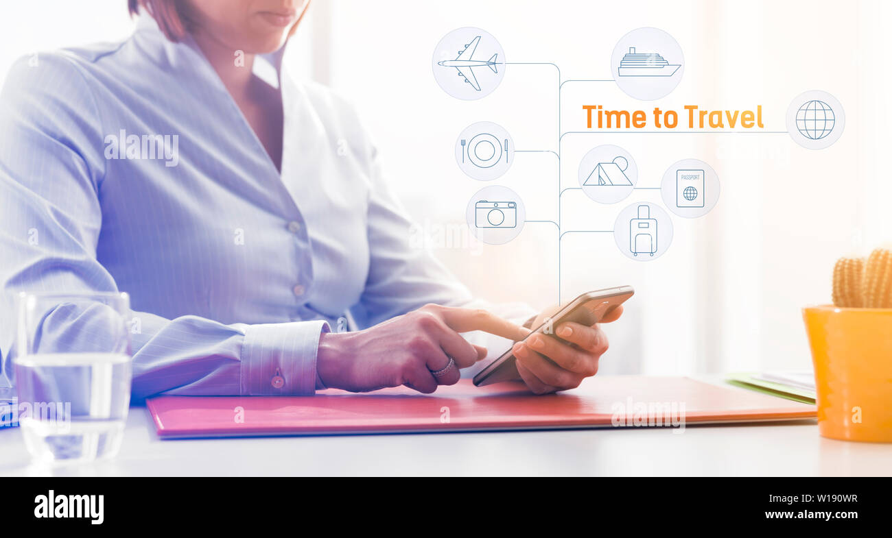 Woman booking her vacation using a travel app on her smartphone, user ...