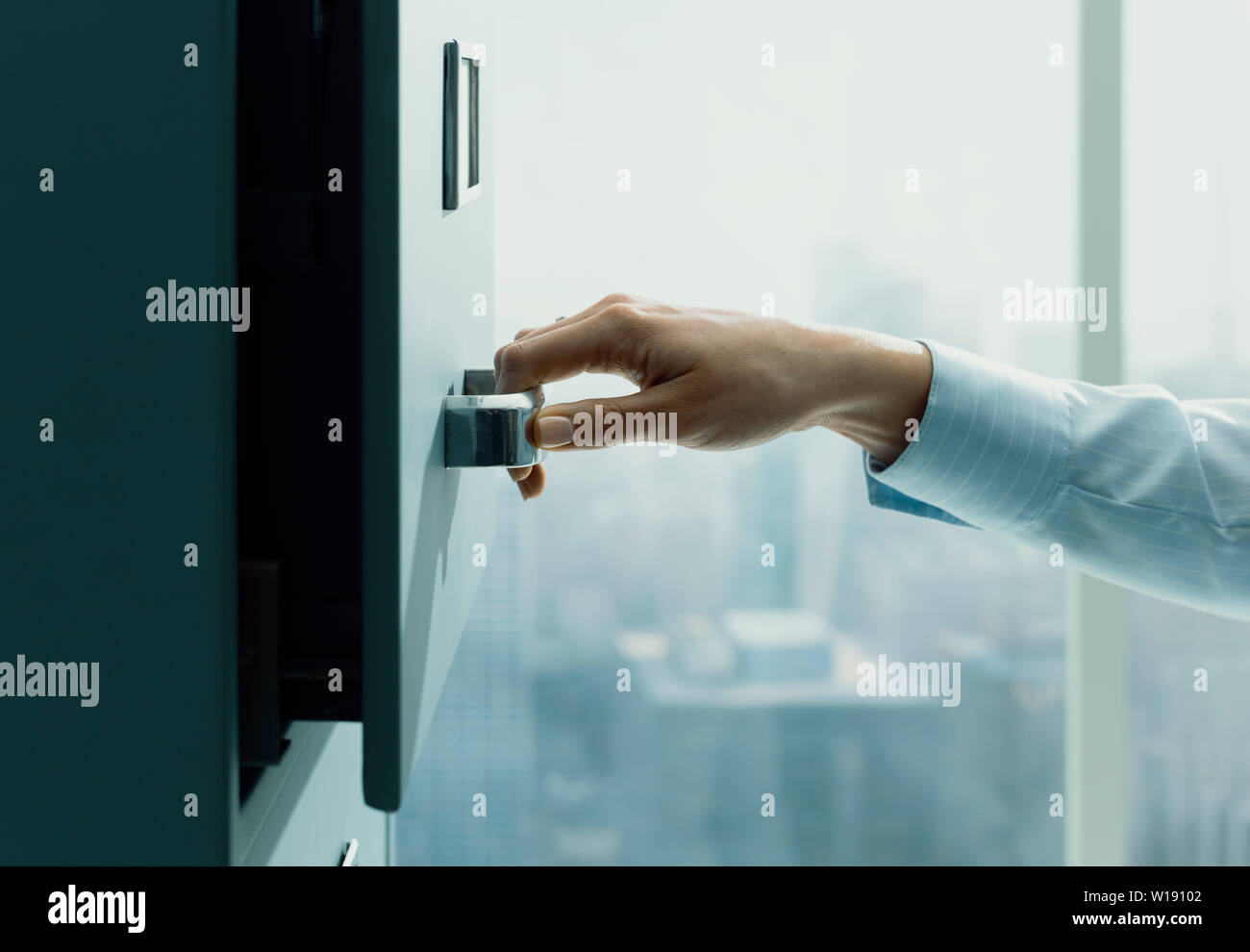 Professional secretary working and searching files in the archive, she ...