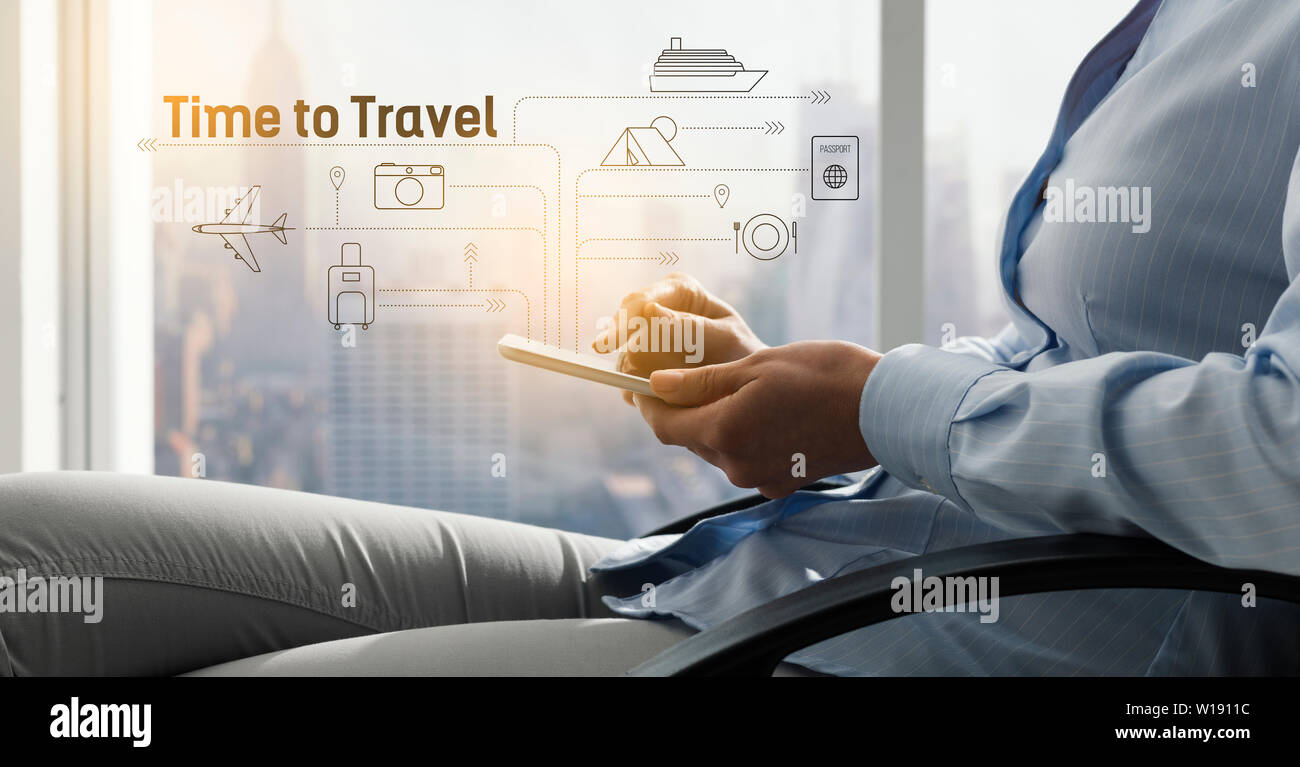 Woman booking her vacation online using a travel app on her smartphone ...