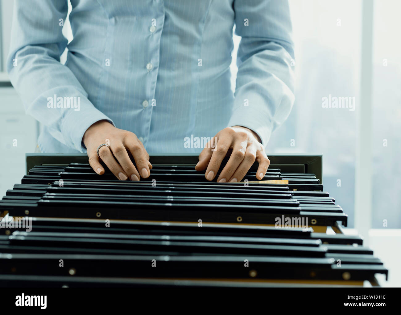Female office worker searching files and paperwork in the archive, she ...