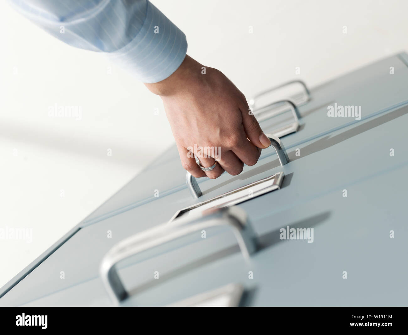 Professional secretary working and searching files in the archive, she ...