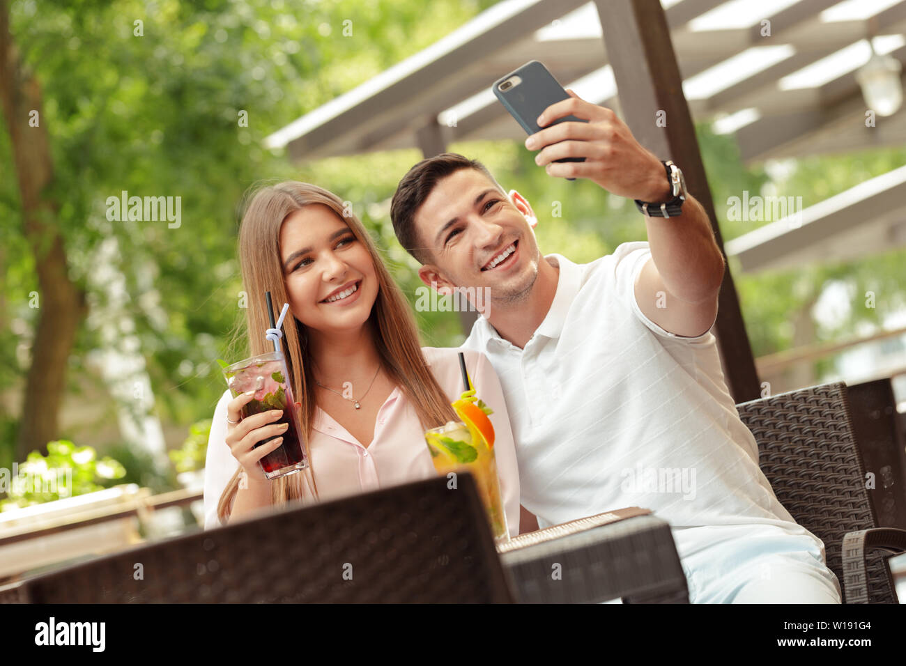 couple using mobile phone in cafe Stock Photo - Alamy