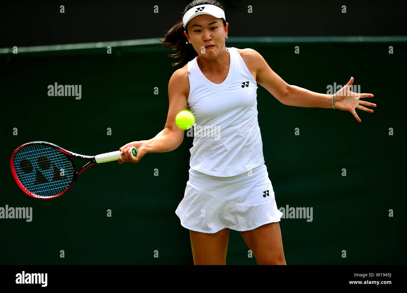 Lin Zhu in action on day one of the Wimbledon Championships at the All ...