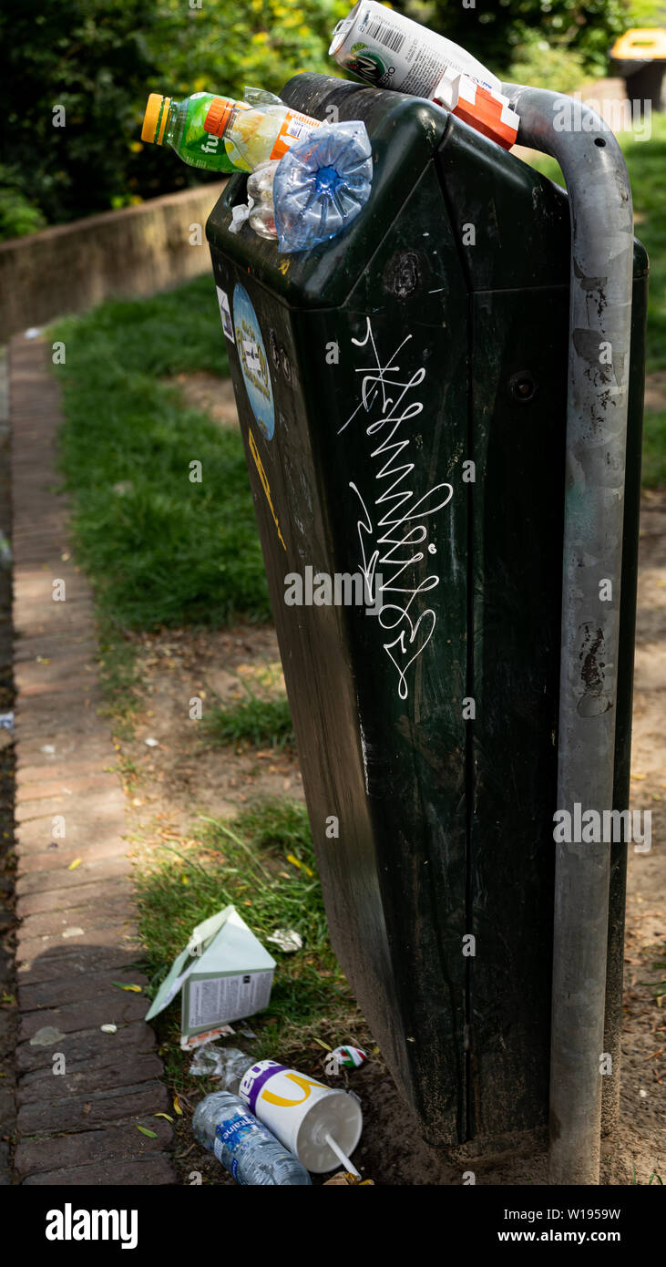 Overflowing garbage bin in the city centre Stock Photo - Alamy