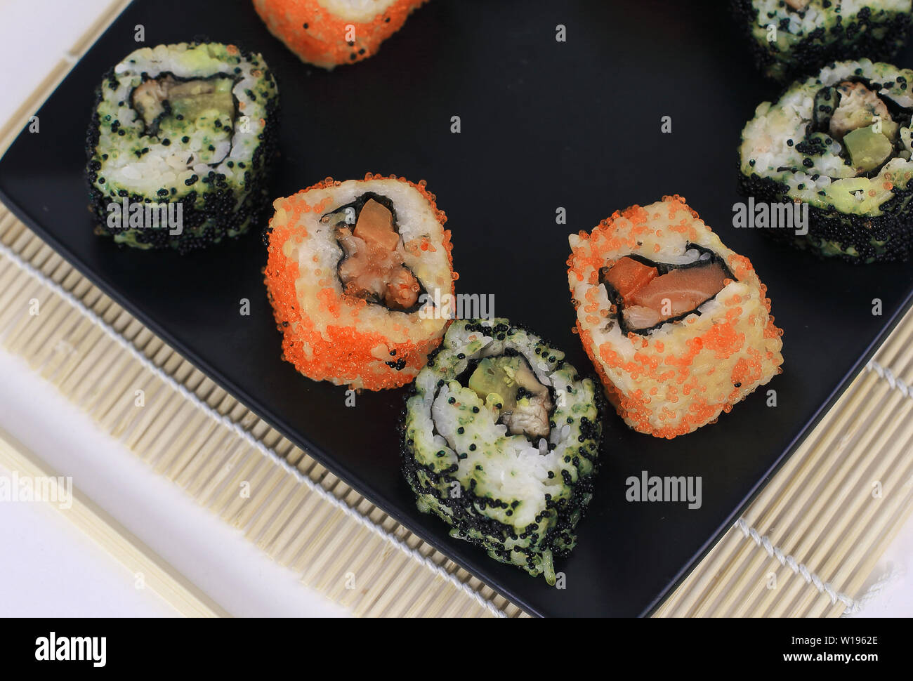 different types of Maki sushi on a black plate.isolated on white ...