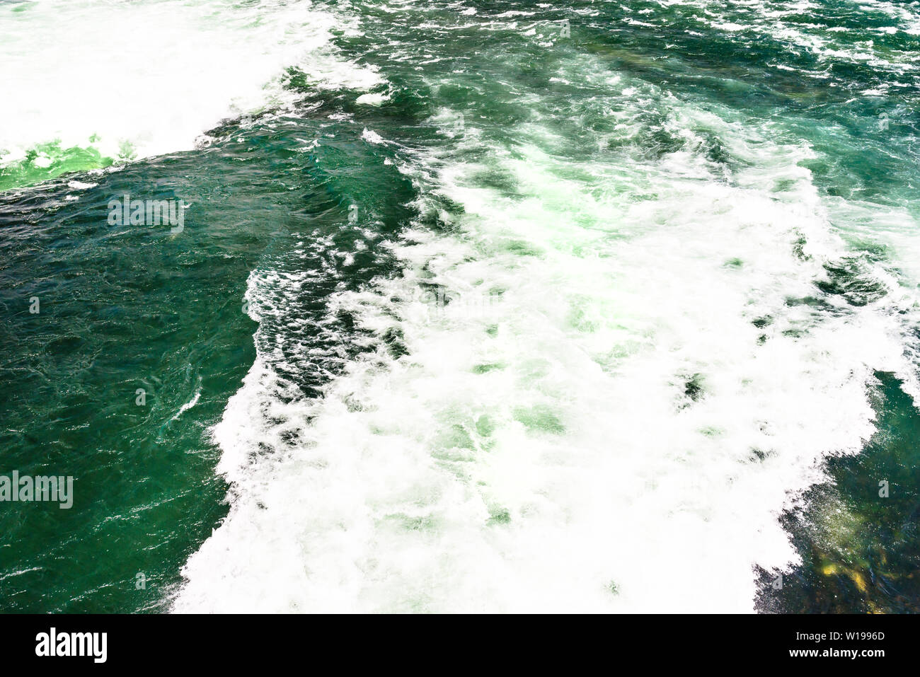 Background made from a rushing, foamy river in a beautiful turquoise ...