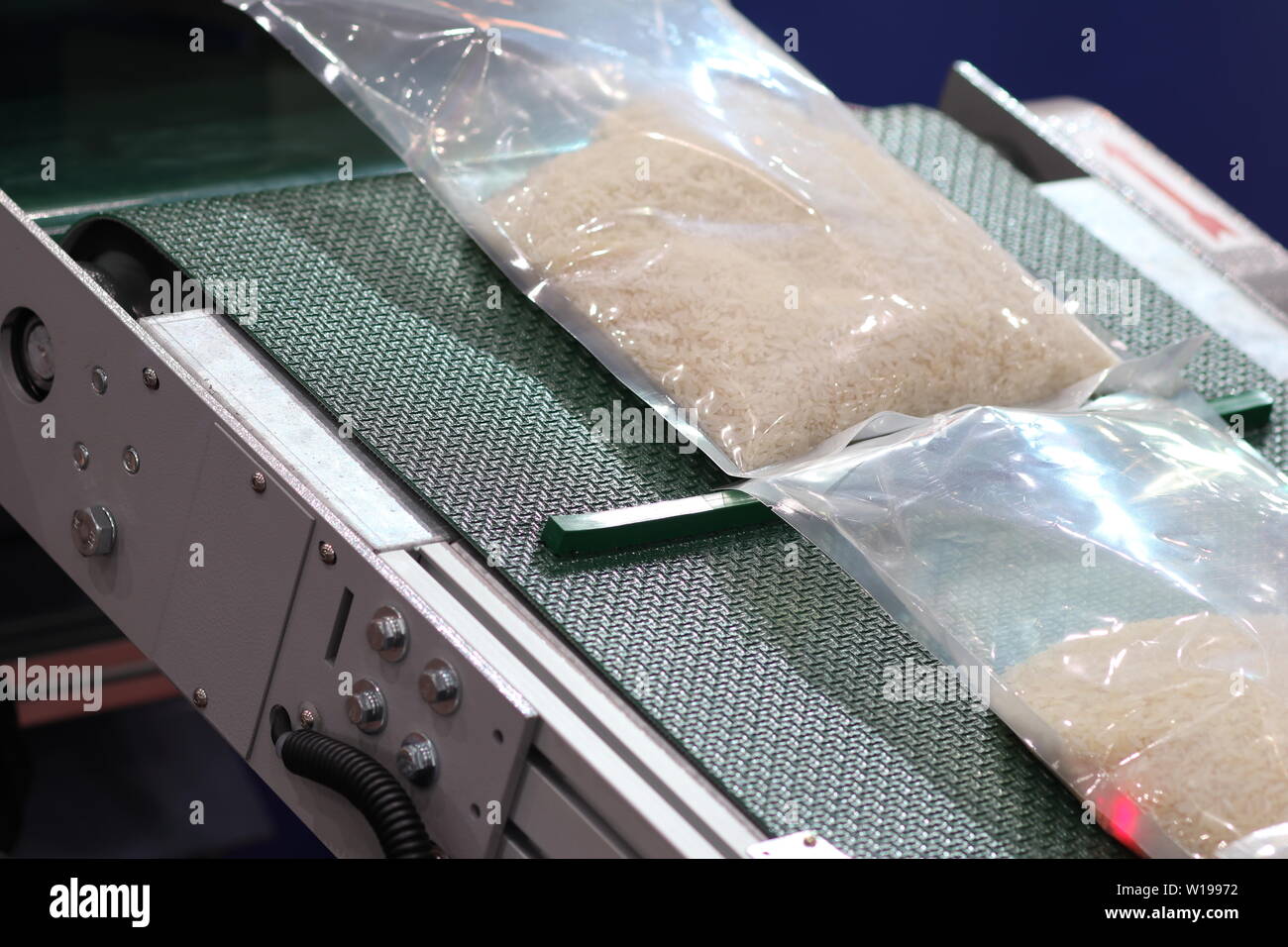 rice packing in plastic bag on conveyor line ; close up Stock Photo - Alamy
