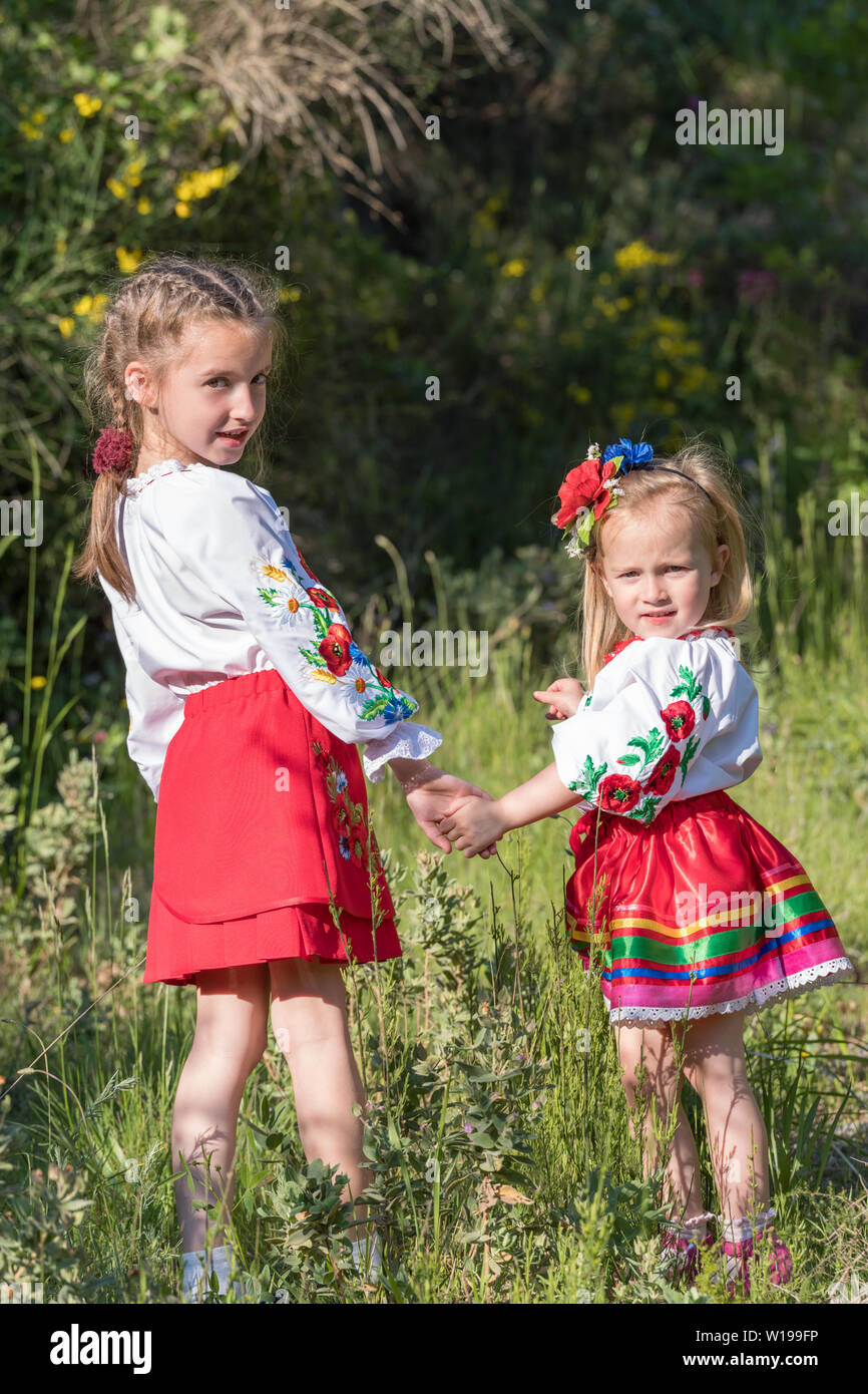 Sisters in traditional Ukrainian costumes playing in the spring ...