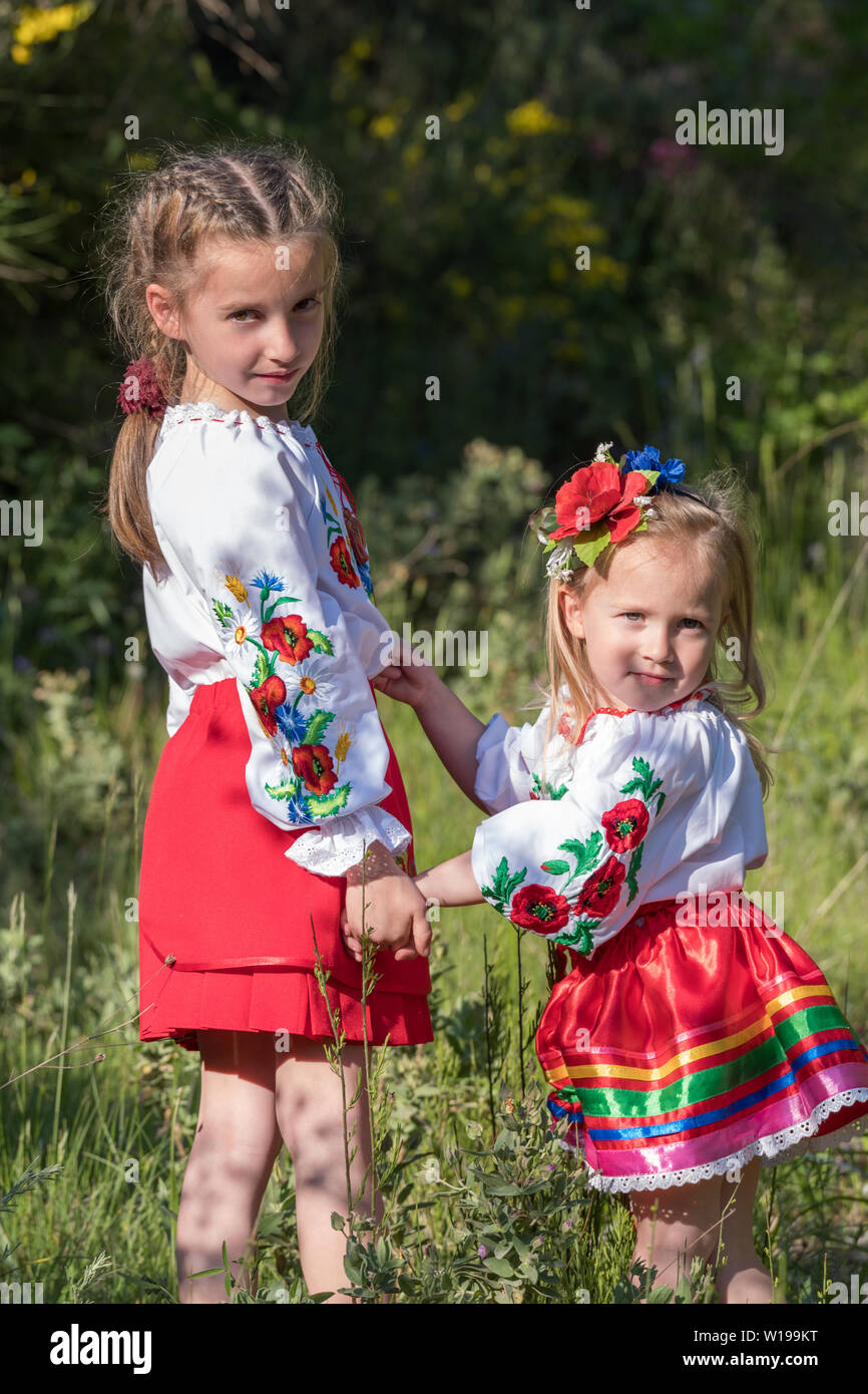 Sisters in traditional Ukrainian costumes playing in the spring ...