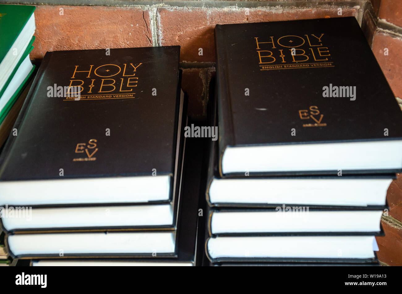 Stacks of bibles on a table in a church Stock Photo - Alamy