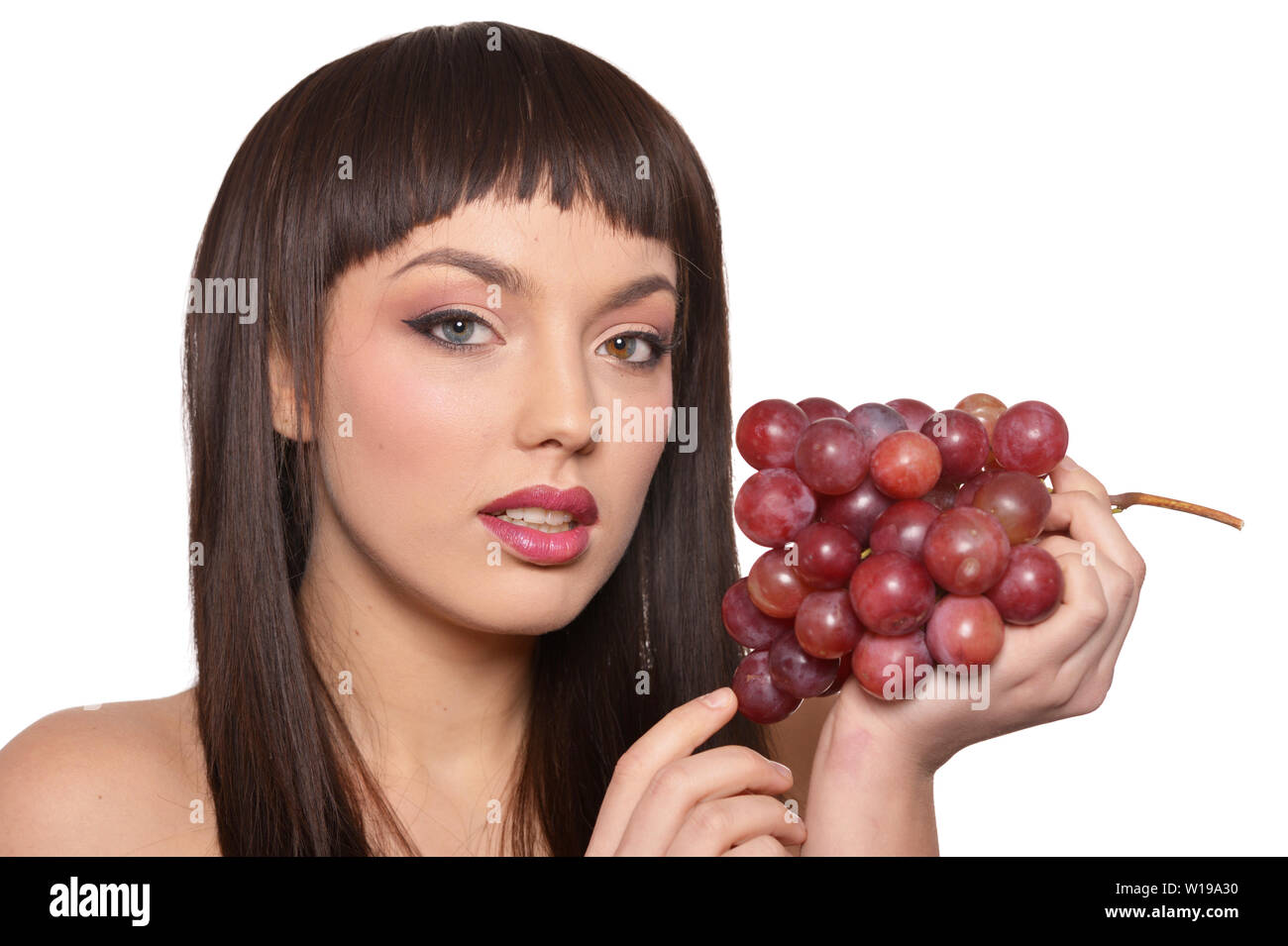 Portrait of young woman posing with grapes Stock Photo - Alamy