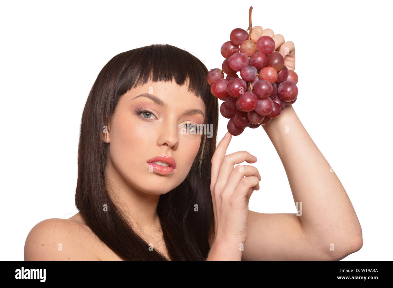 Portrait of young woman posing with grapes Stock Photo - Alamy