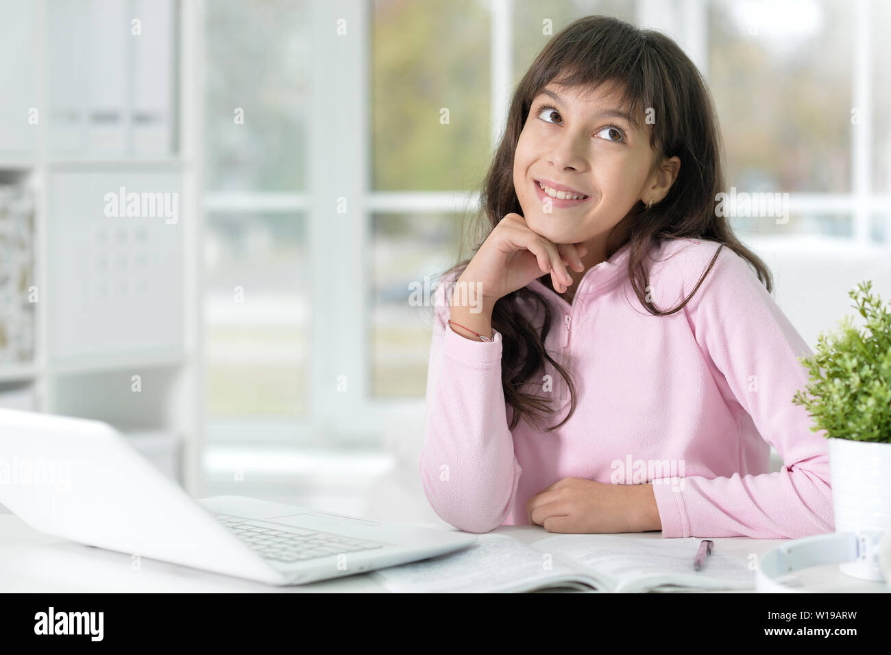 Portrait of beautiful girl with laptop studying at desk Stock Photo - Alamy