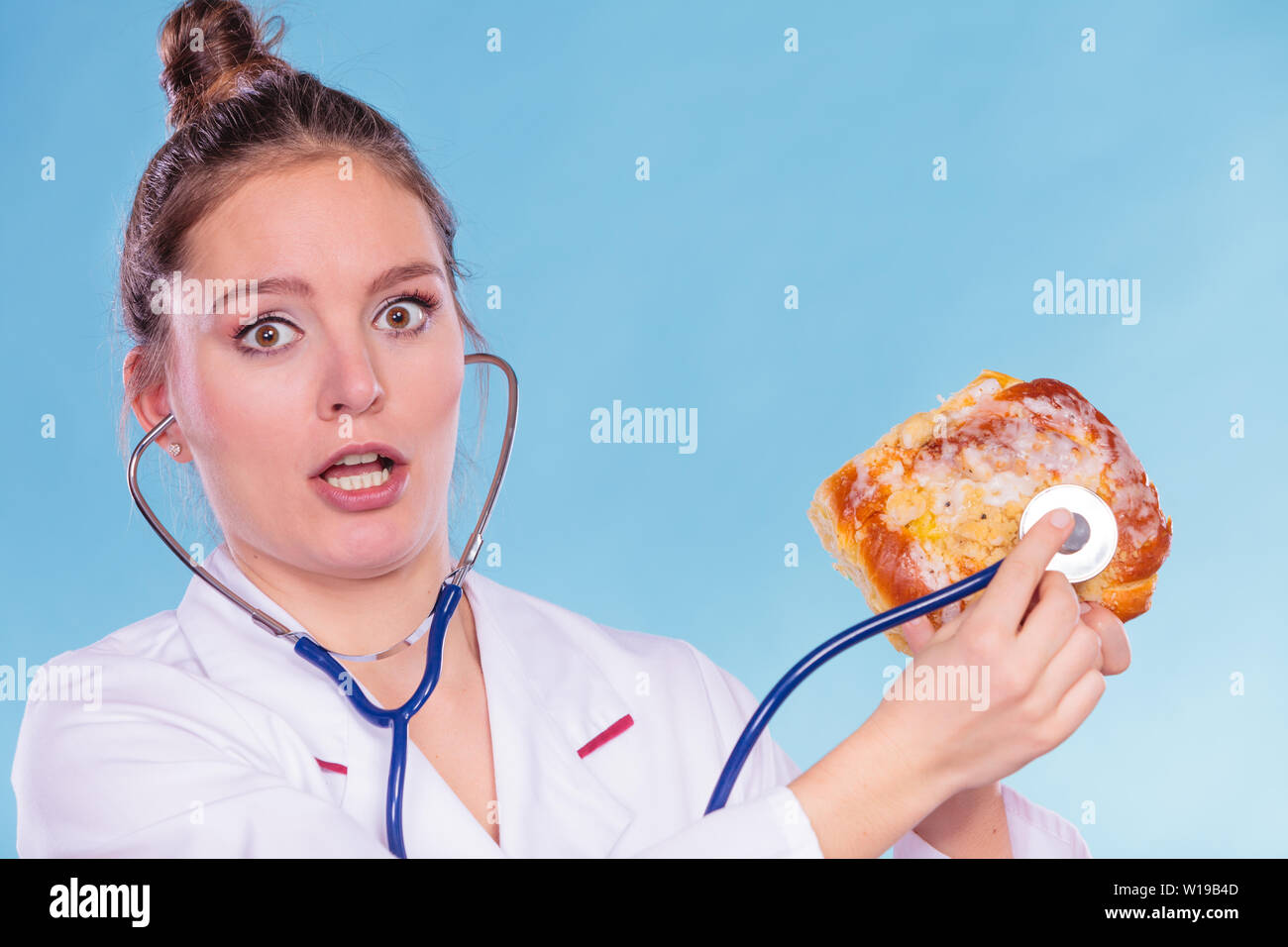 Scared terrified dietitian nutritionist checking examine sweet roll bun ...
