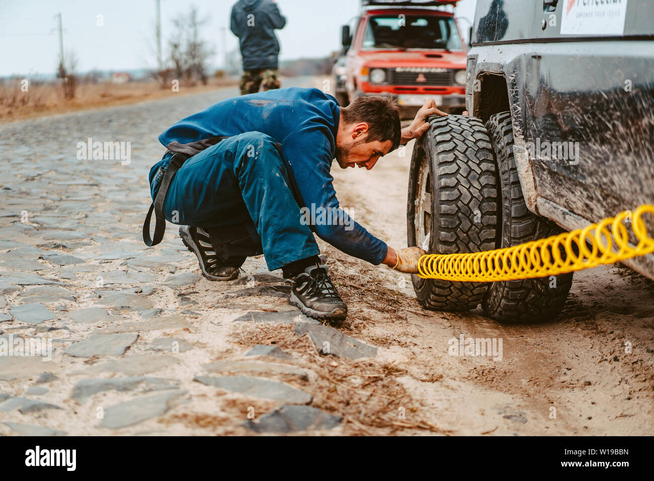 A man pumps air wheel with a compressor Stock Photo - Alamy