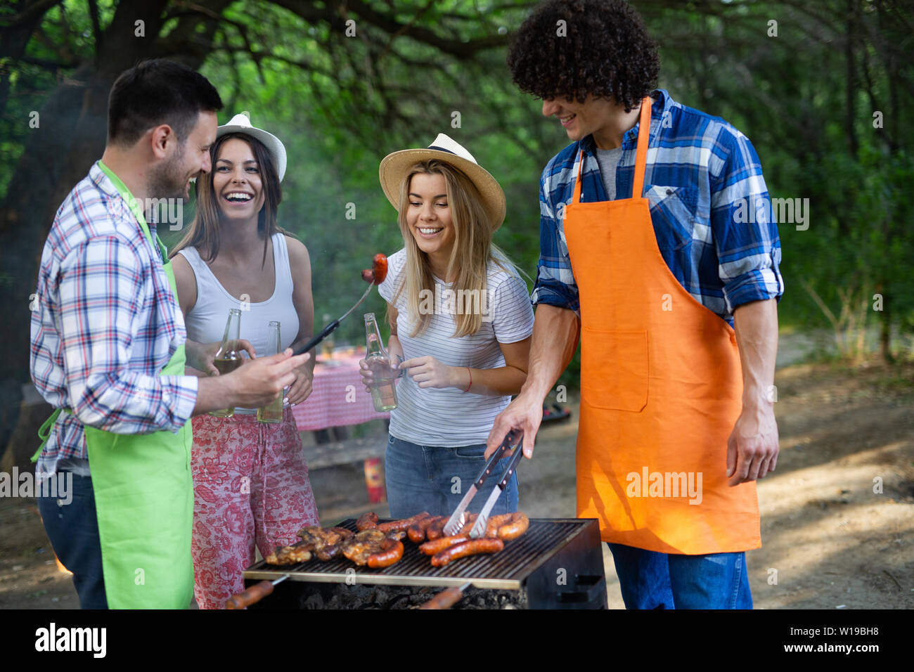 Group of friends having a barbecue party in nature Stock Photo - Alamy
