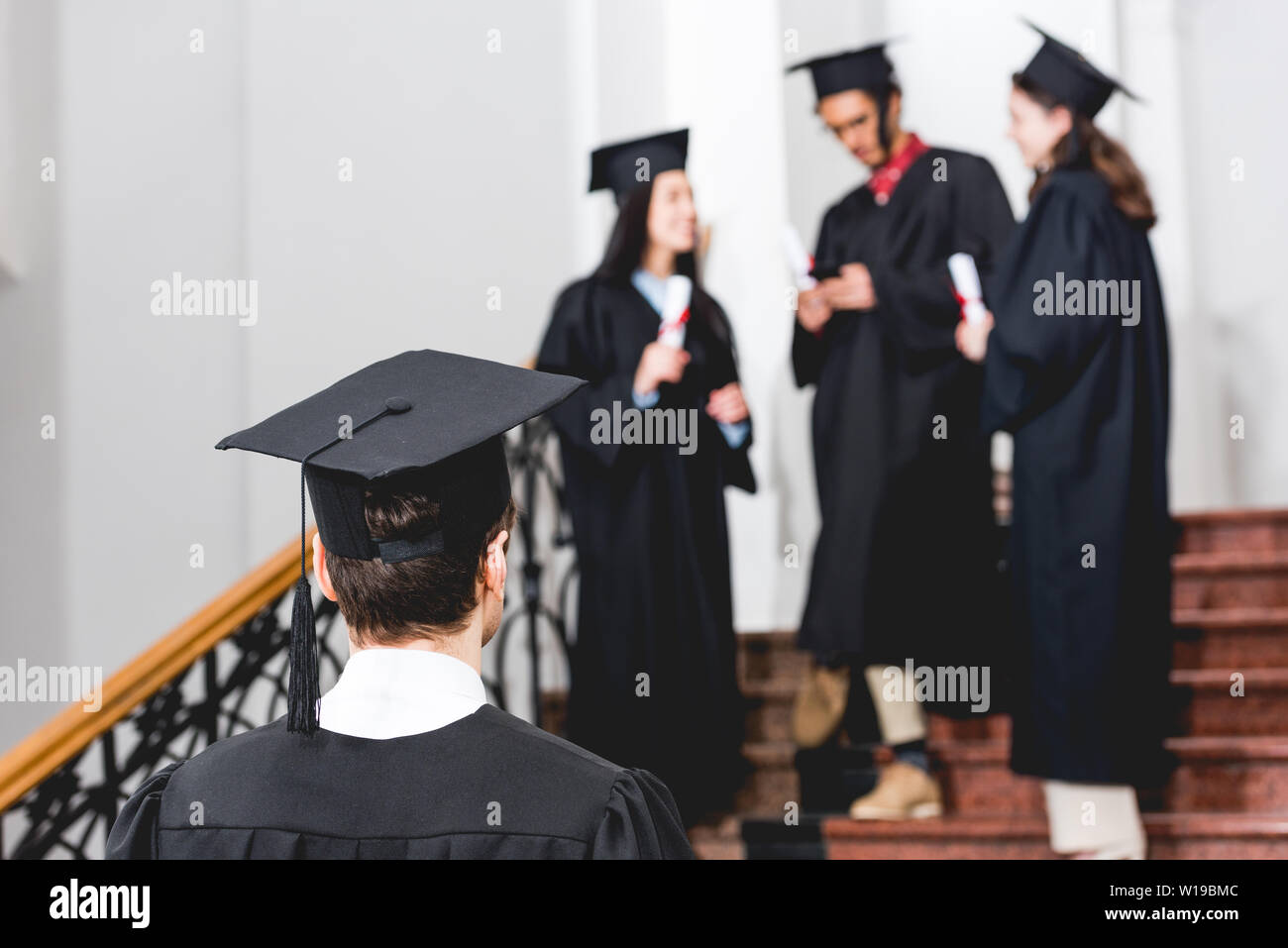back view of student in graduation cap standing in university Stock ...