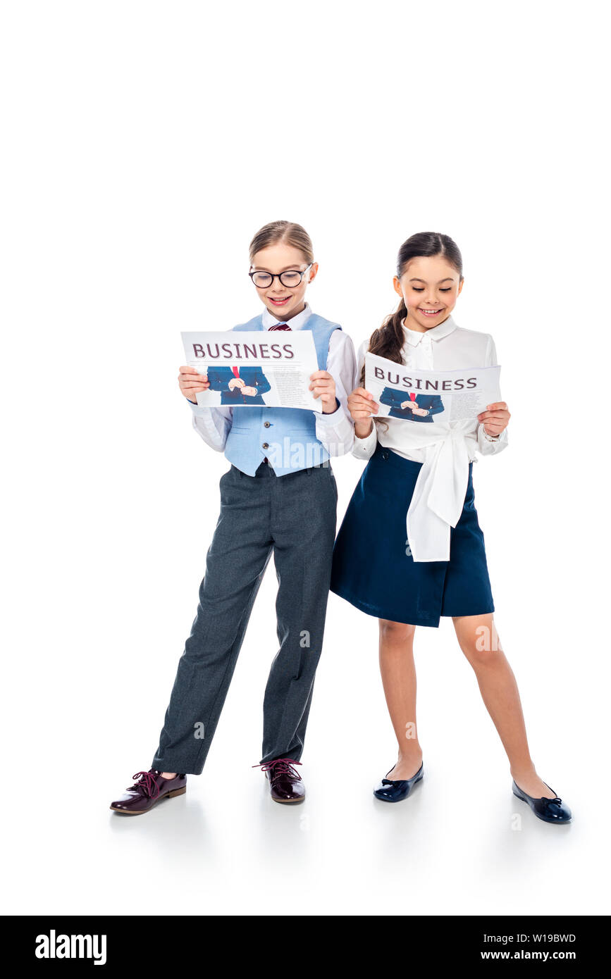 schoolgirls in formal wear reading business newspapers On White Stock ...